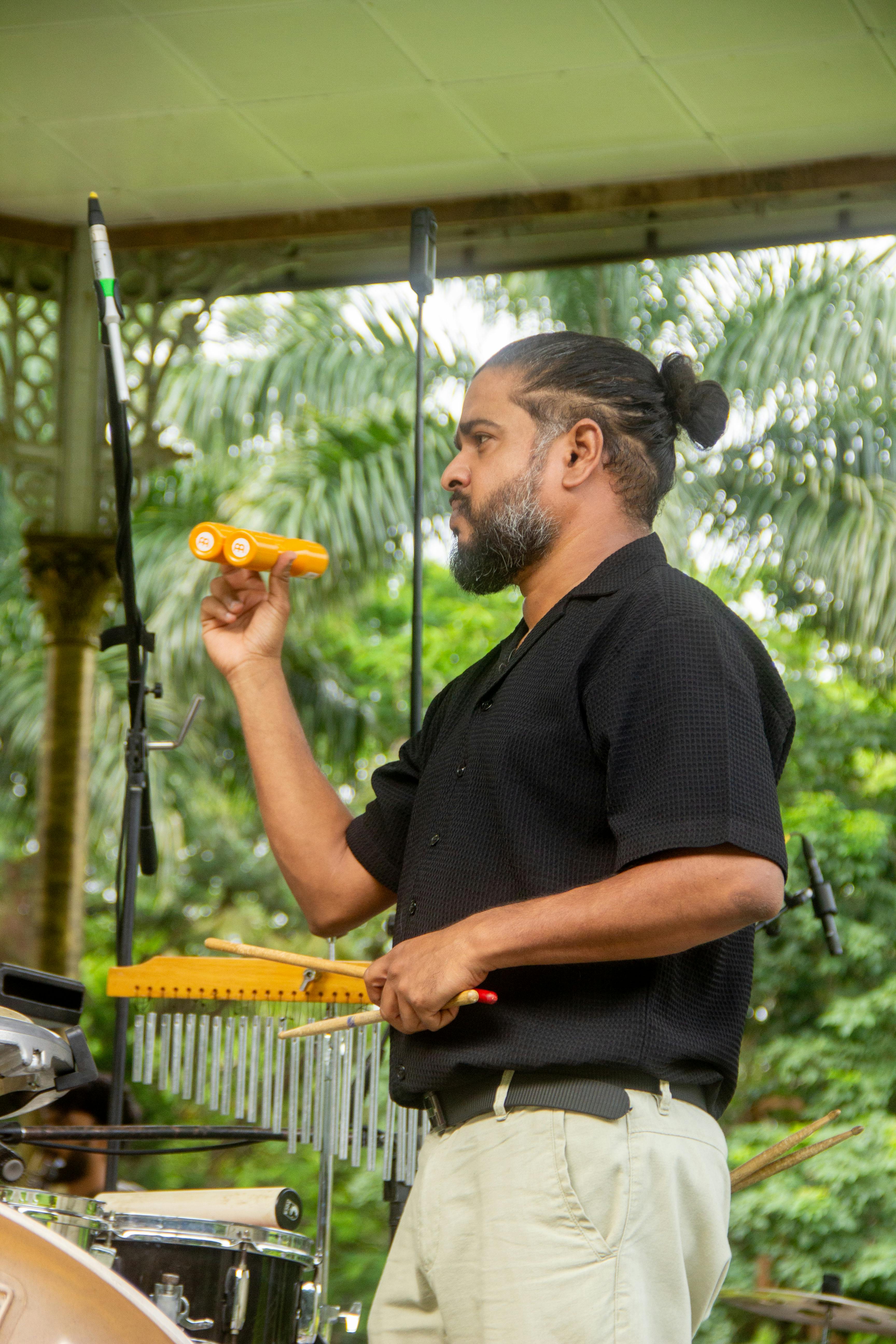 Musician Playing Percussion Instruments Outdoors · Free Stock Photo
