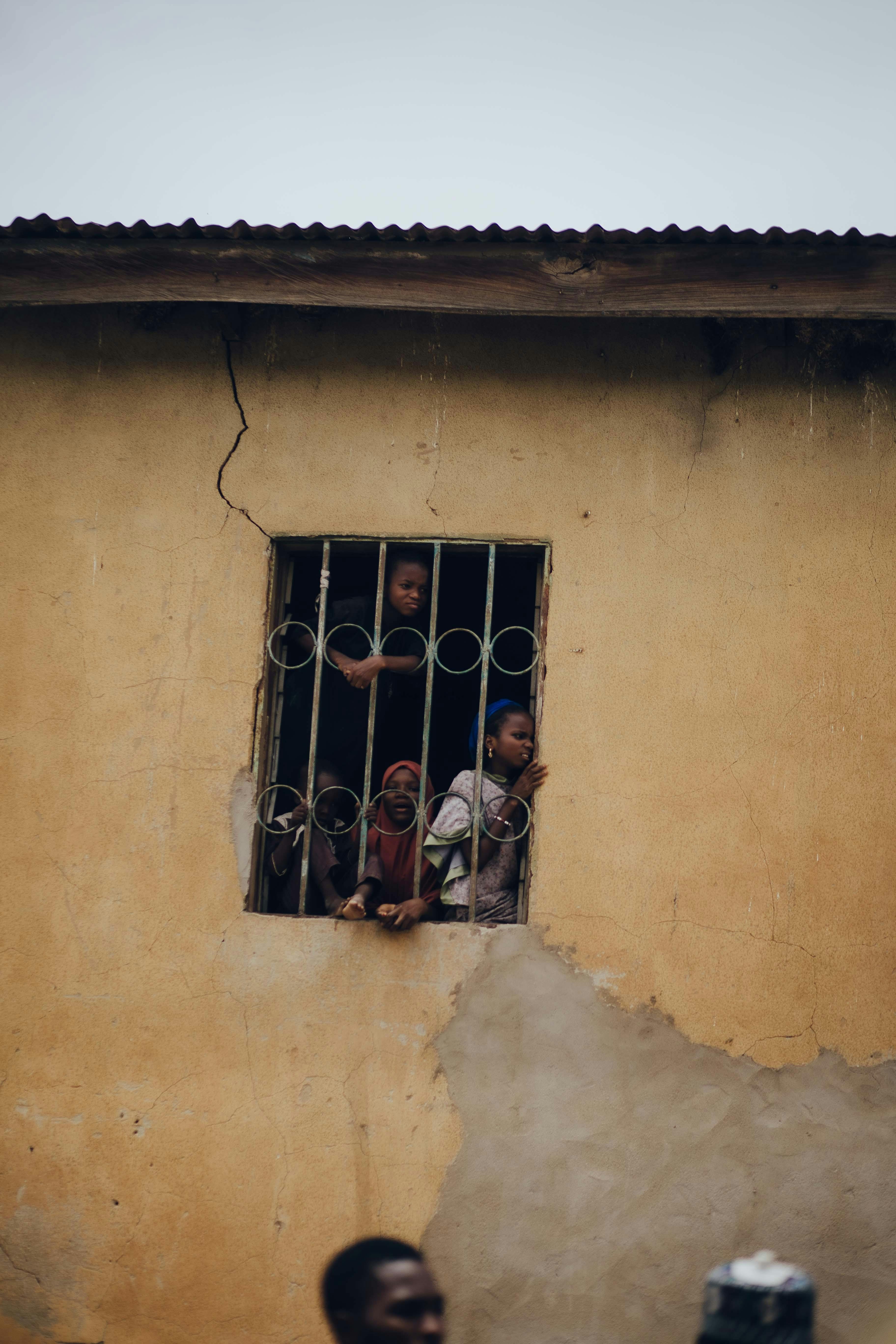 Children Peering Through a Window in Nigeria · Free Stock Photo