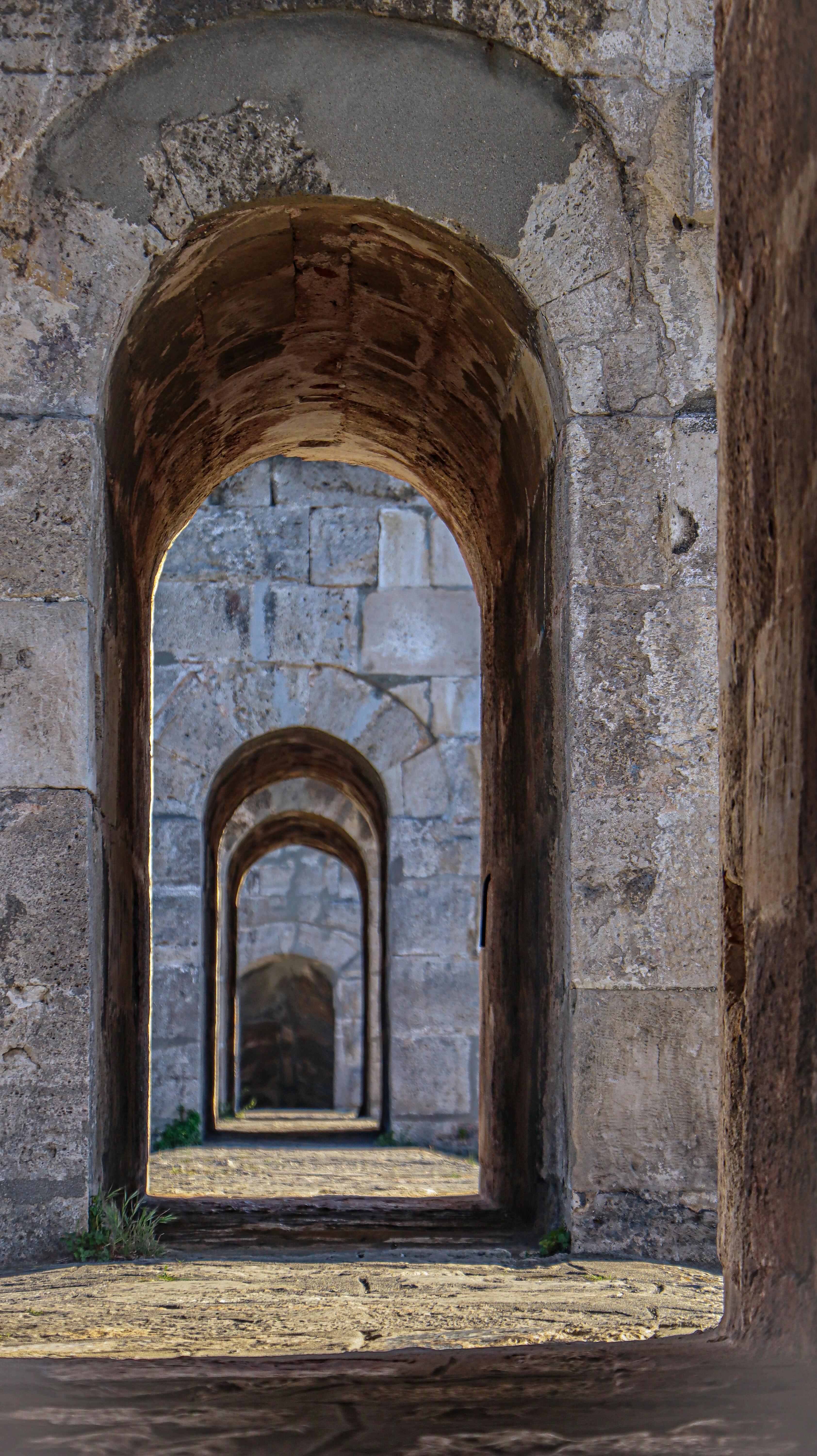 Historic Stone Archway Corridor Perspective · Free Stock Photo