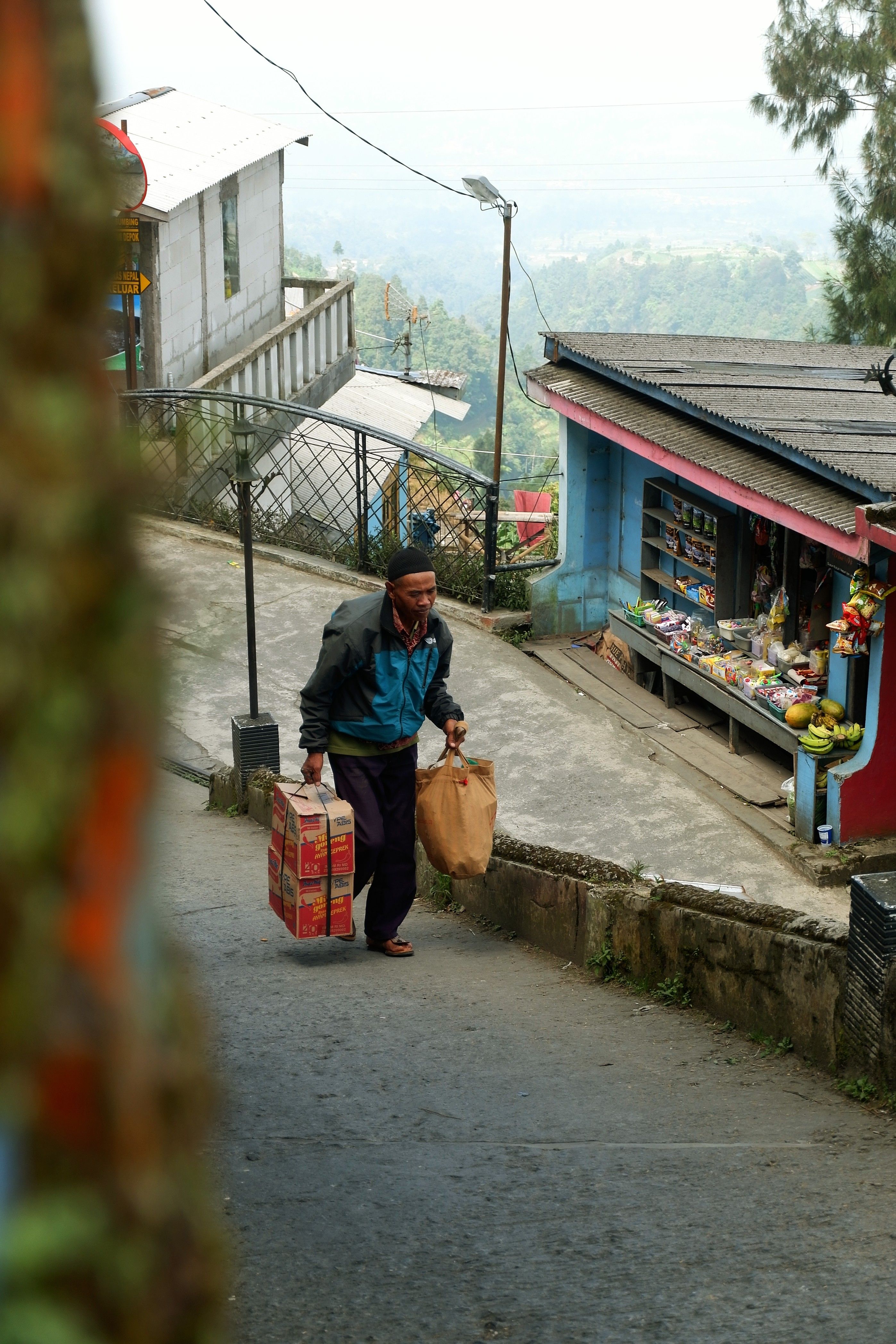Man Carrying Goods on Hill in Rural Indonesia · Free Stock Photo