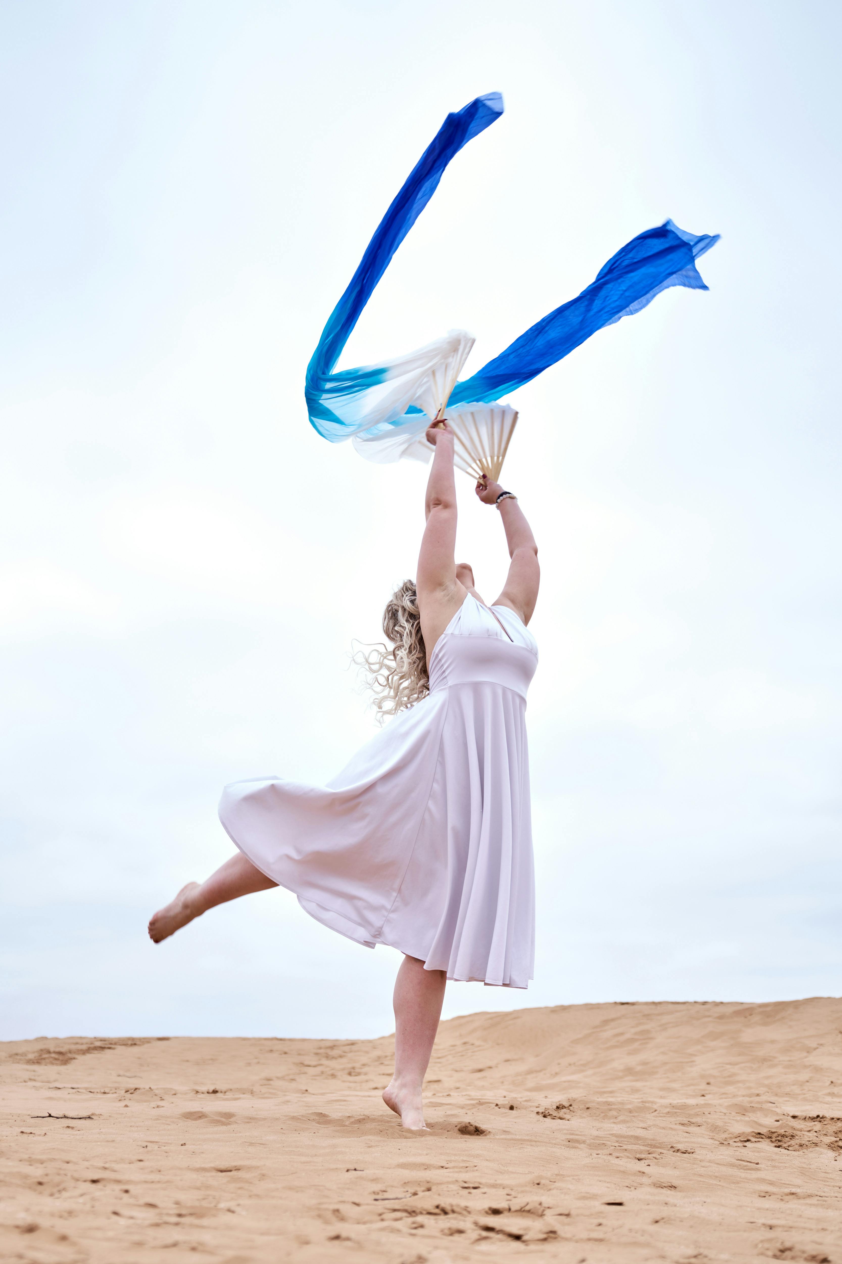 Graceful Dance on Sandy Dunes with Blue Silks · Free Stock Photo
