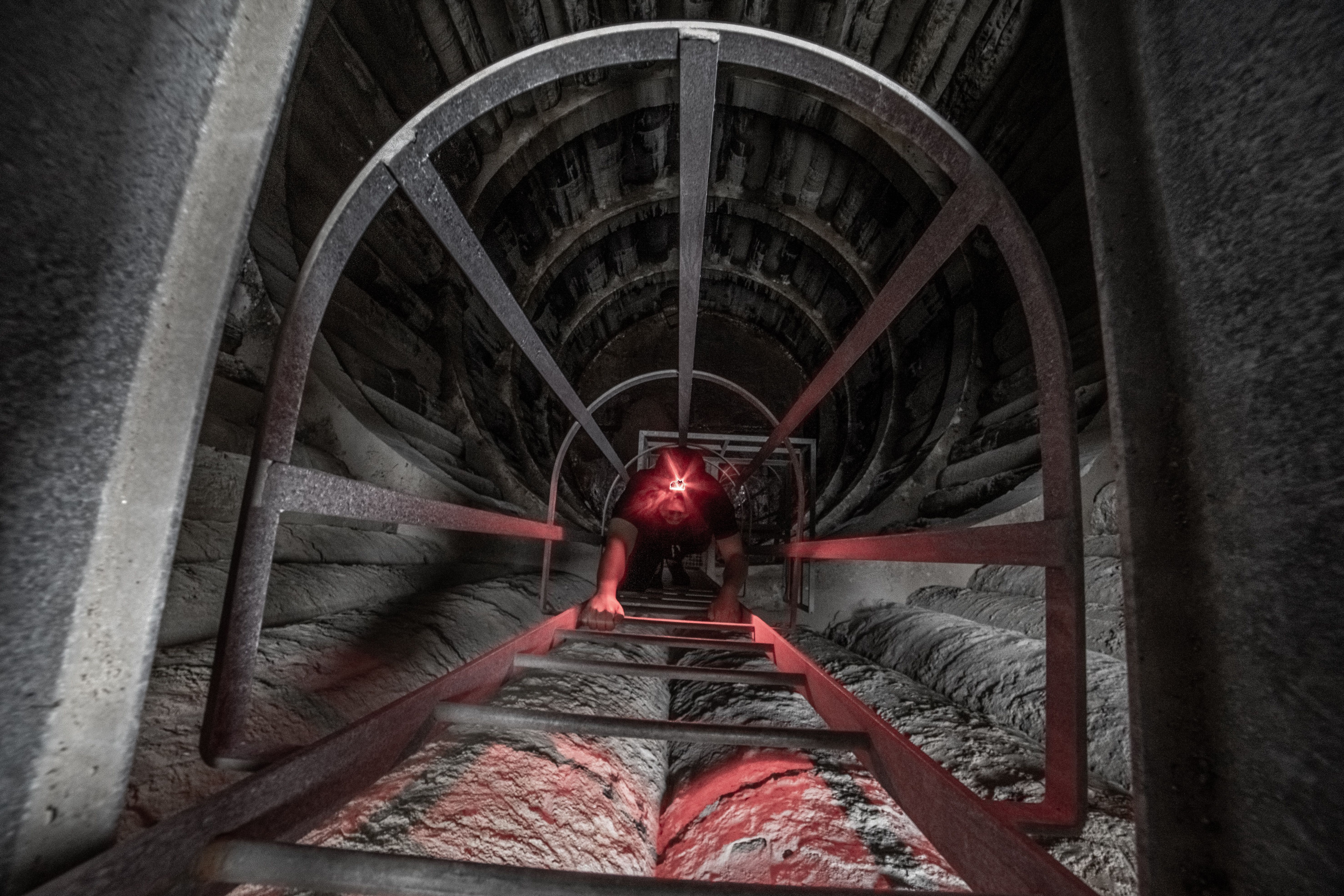 Adventurer Climbing Ladder in Dark Tunnel · Free Stock Photo