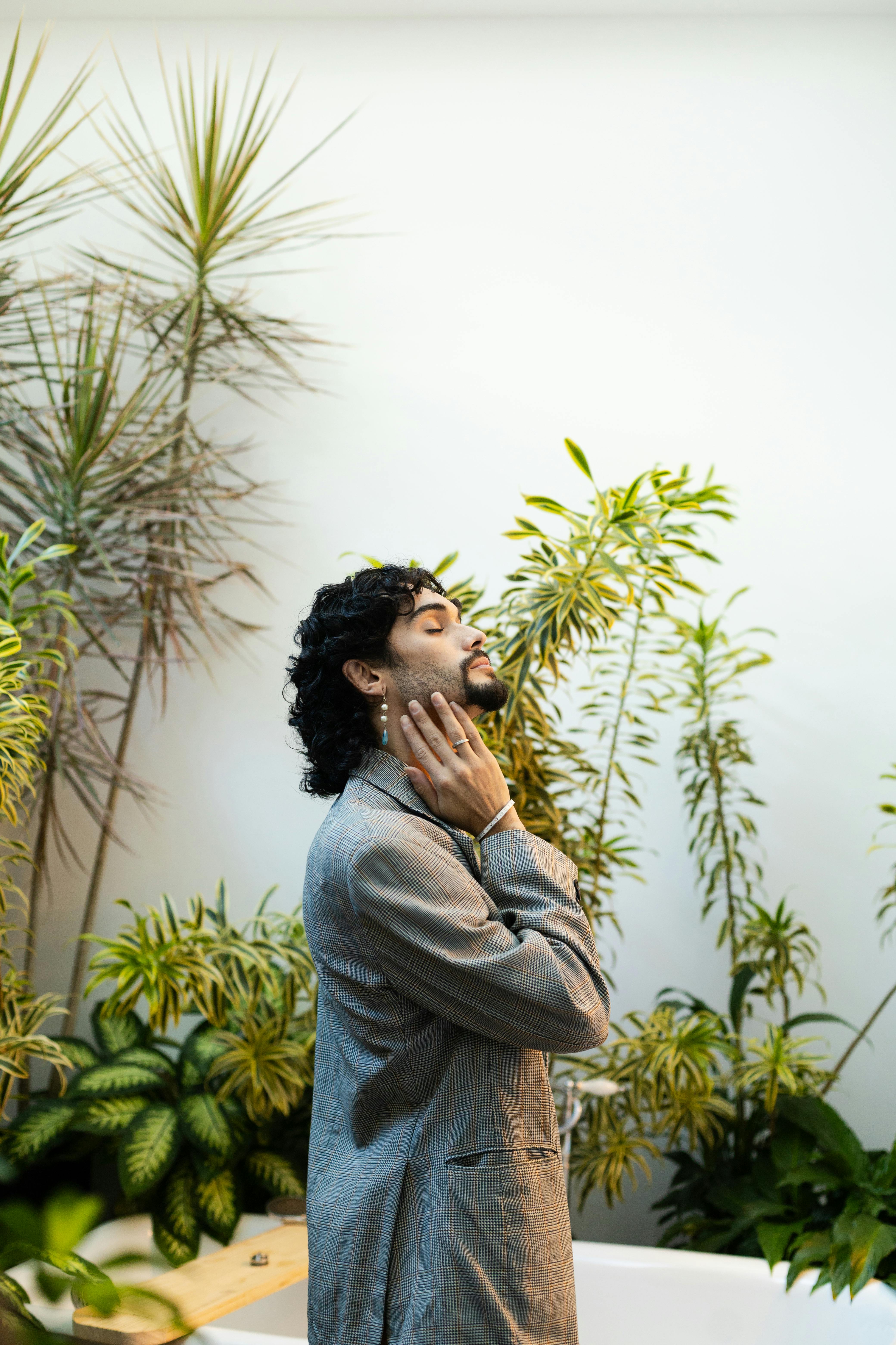 Relaxed Man in Indoor Botanical Garden Setting · Free Stock Photo