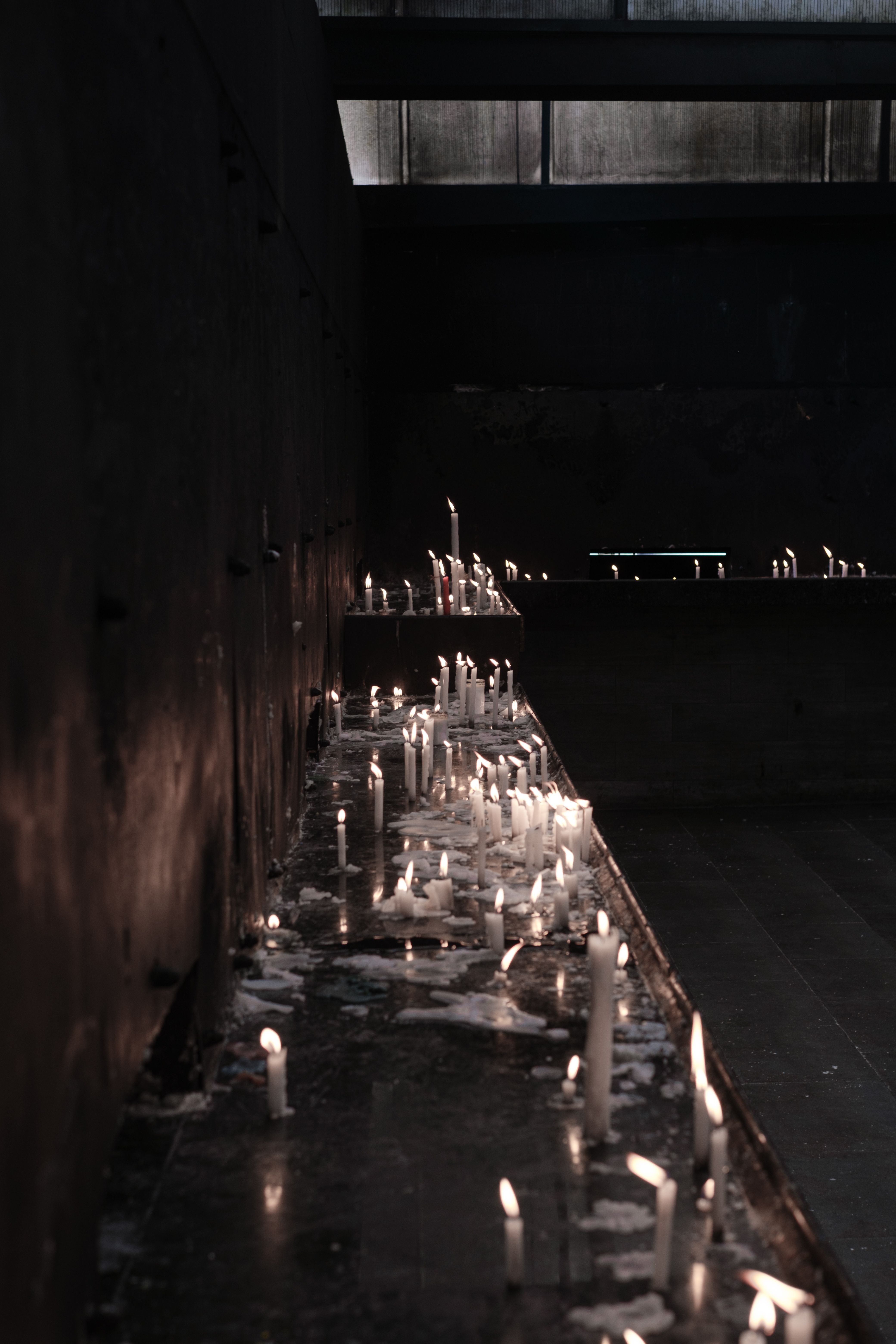 Dimly Lit Church with Flickering Candles · Free Stock Photo