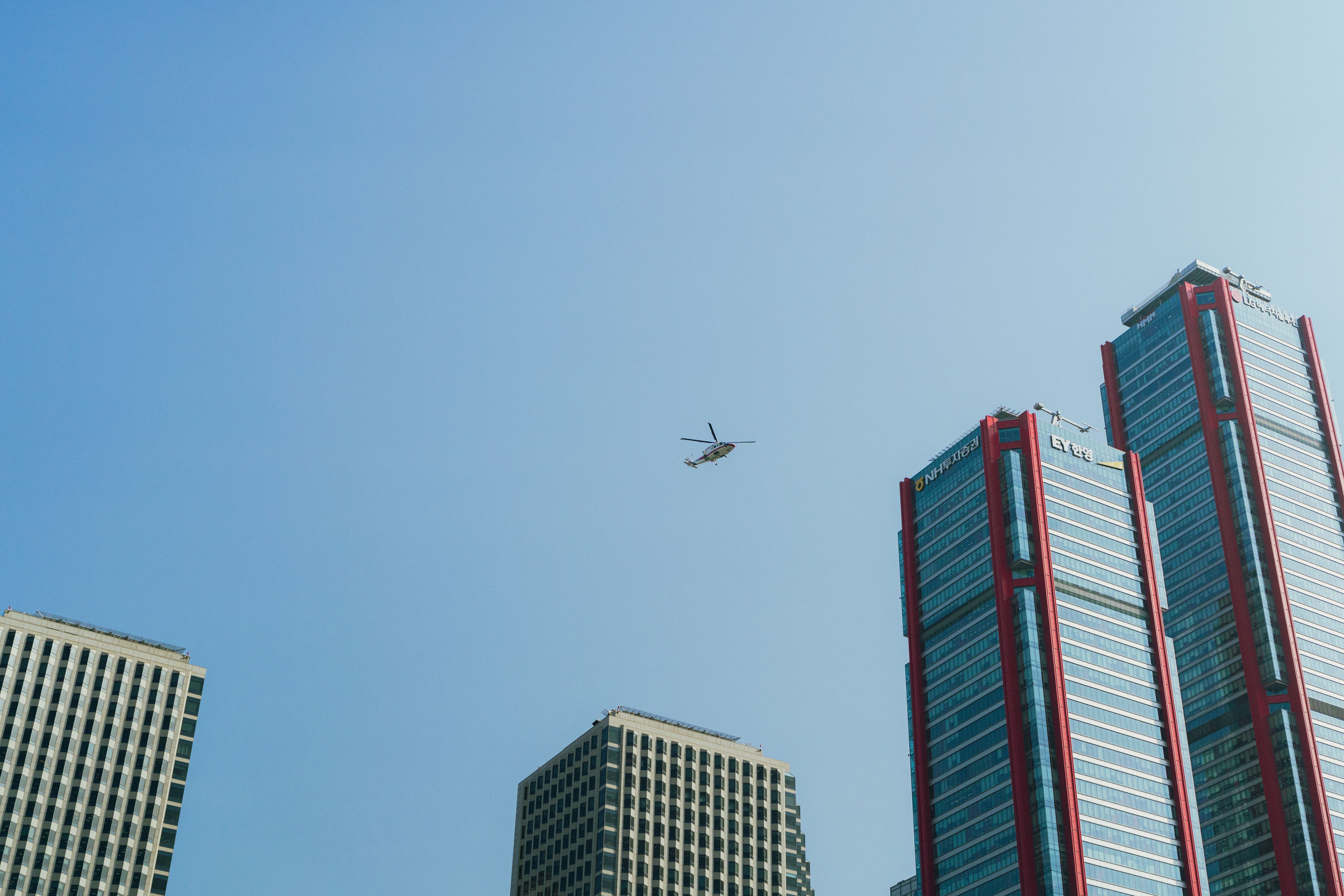Modern Seoul Skyscrapers with Helicopter in Blue Sky · Free Stock Photo