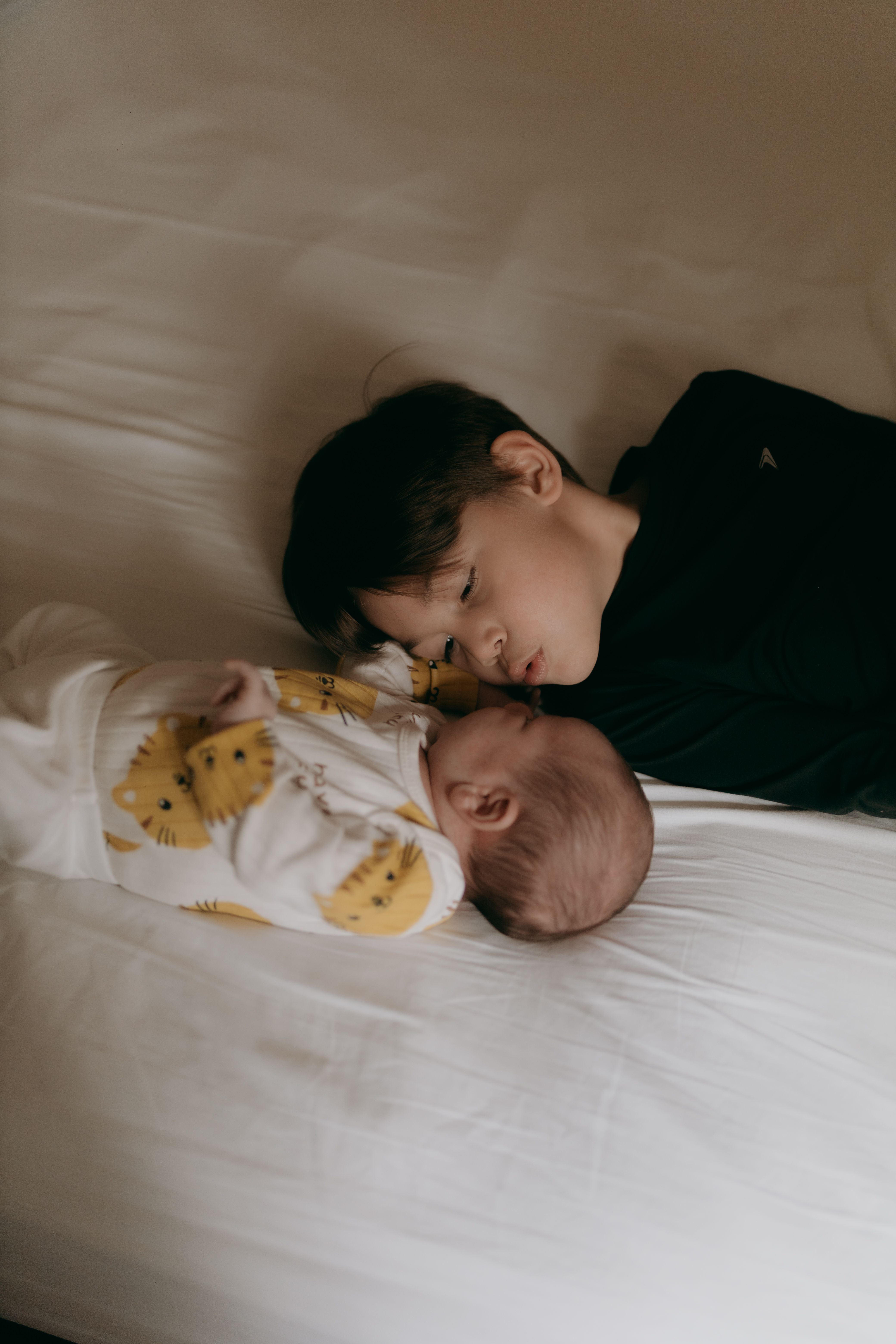 Tender Sibling Moment: Child and Baby Napping · Free Stock Photo