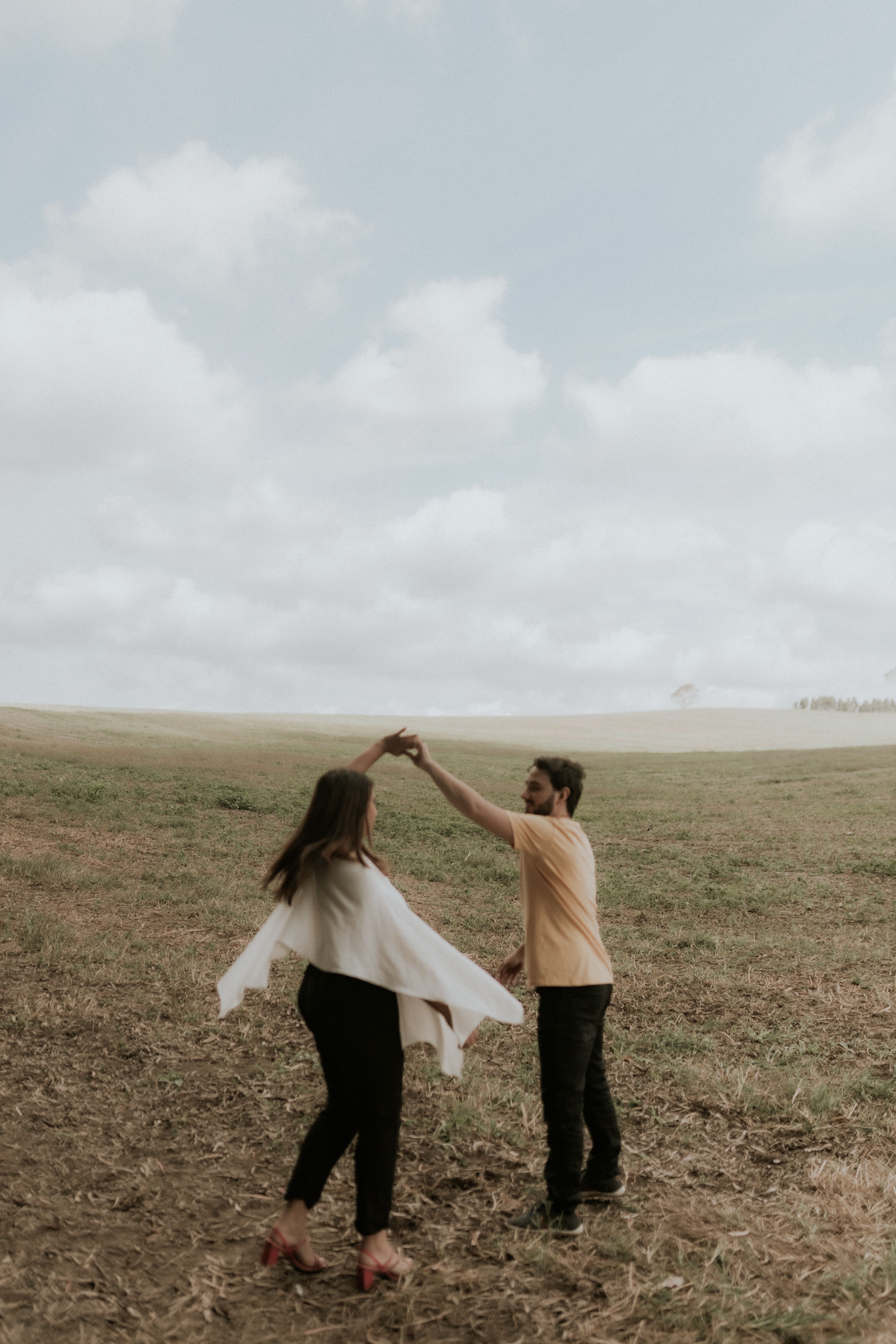 Couple Dancing in Open Field Under Cloudy Sky · Free Stock Photo