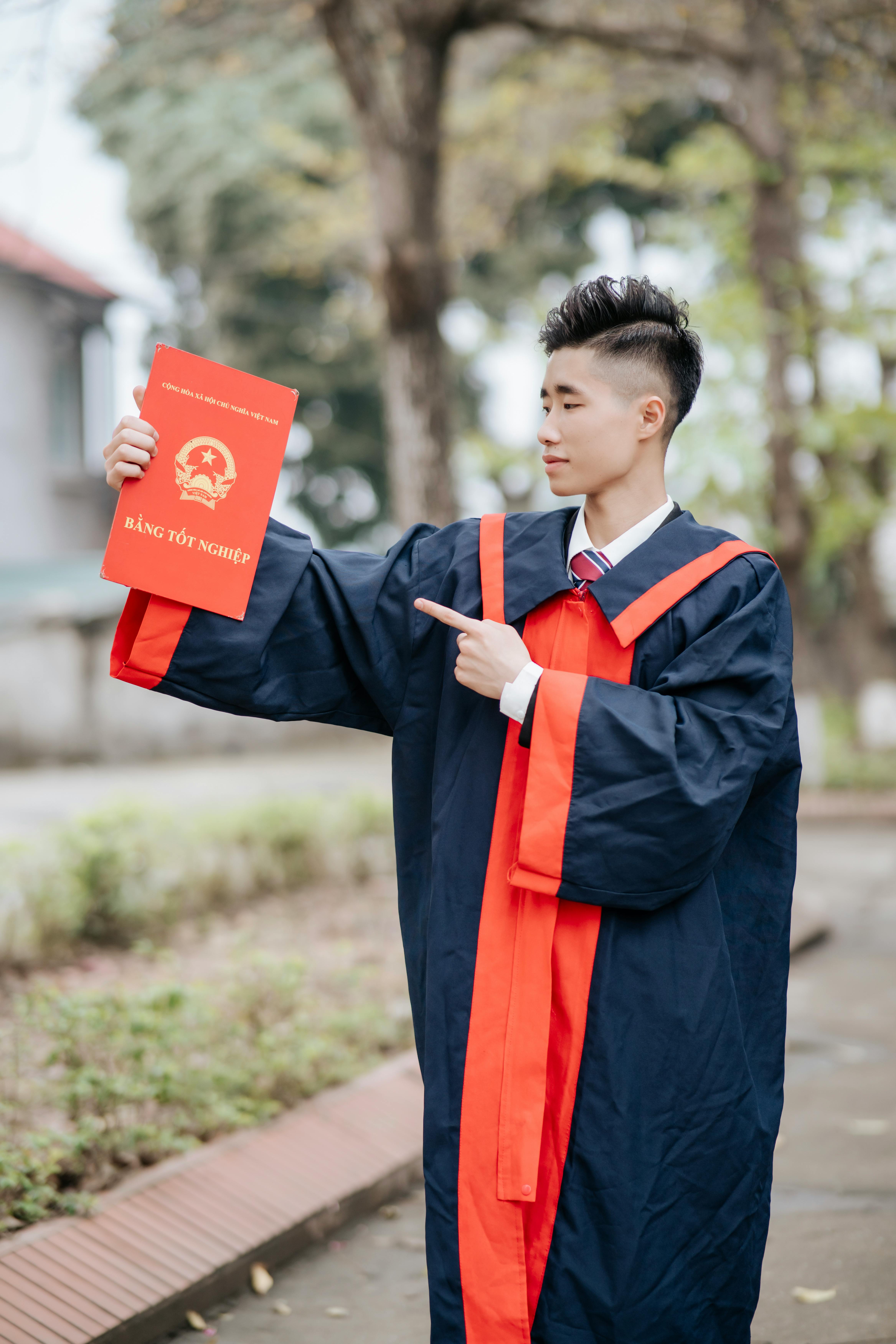 A Newly Graduate Holding His Diploma · Free Stock Photo