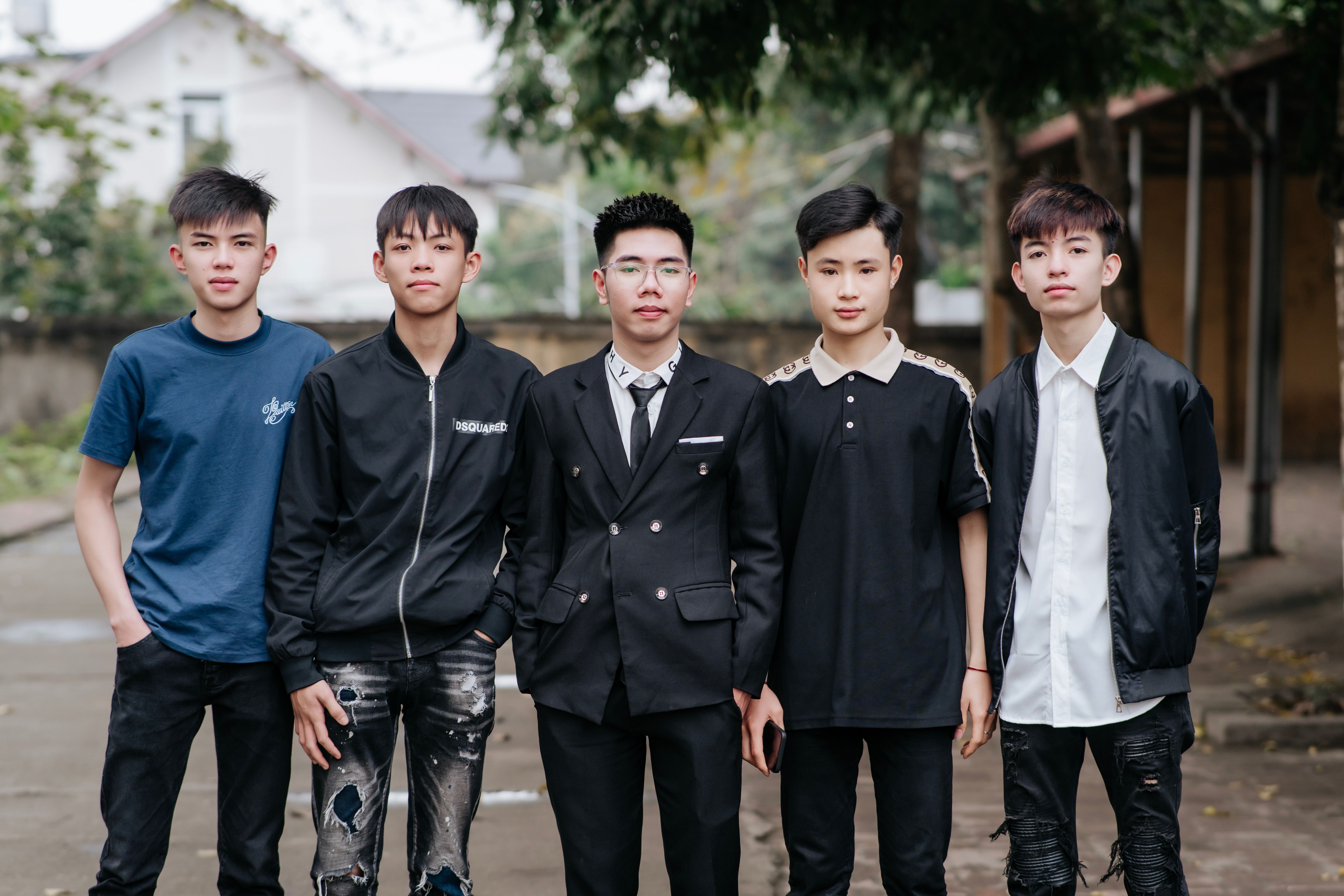 Group of Five Young Men Standing Outdoors · Free Stock Photo