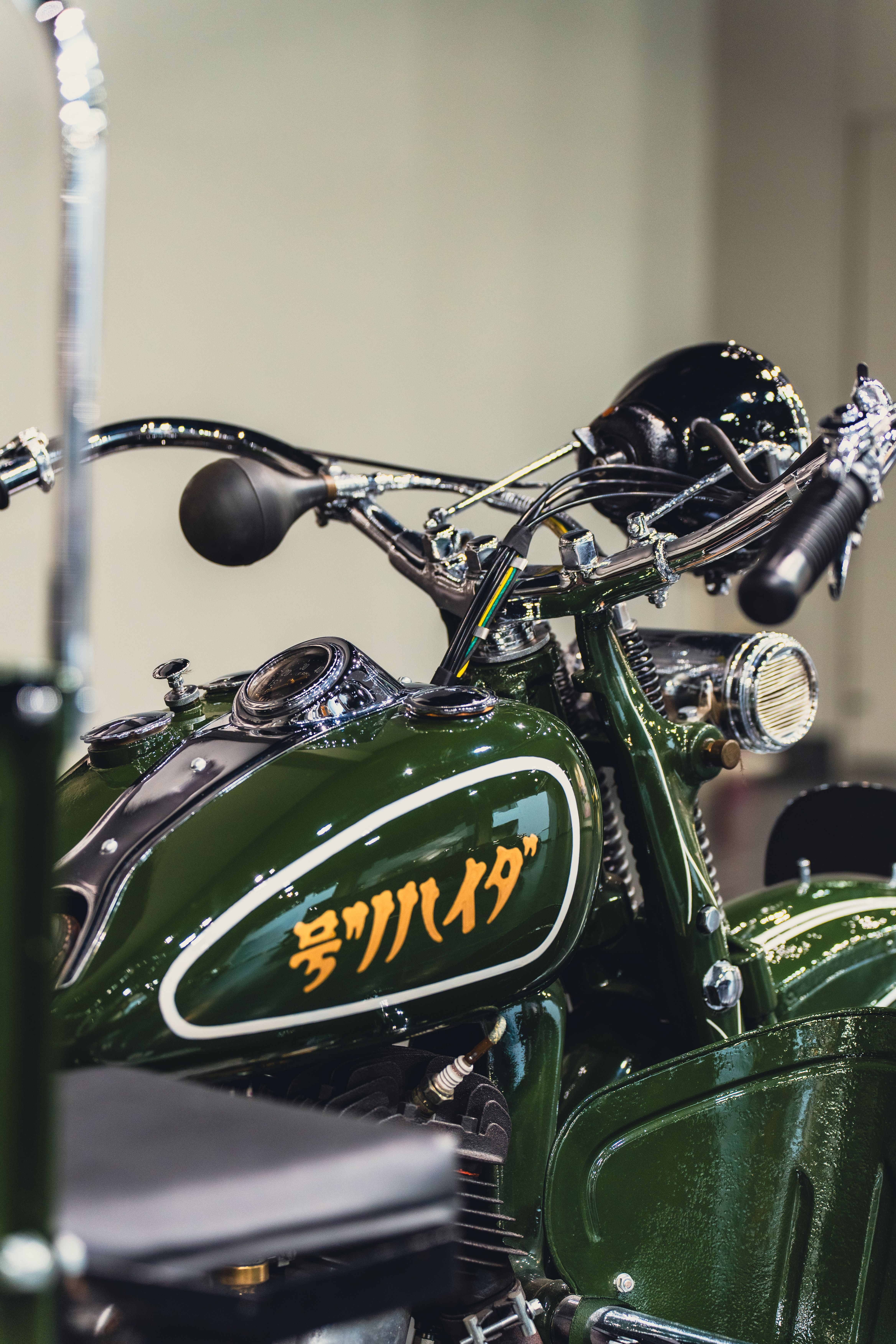 Vintage Green Motorcycle Close-Up Indoors · Free Stock Photo