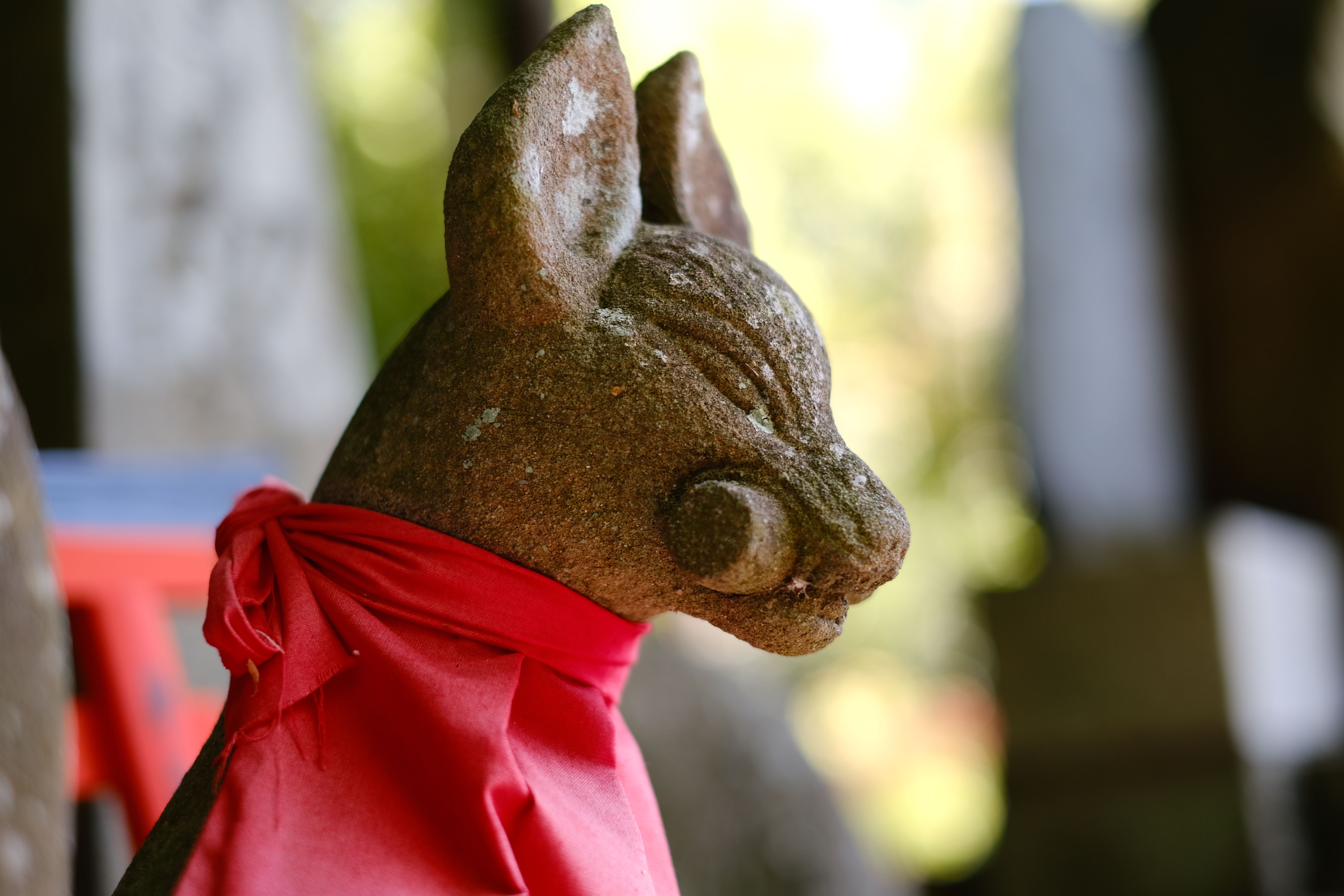 Close-Up of Stone Fox Statue with Red Scarf · Free Stock Photo