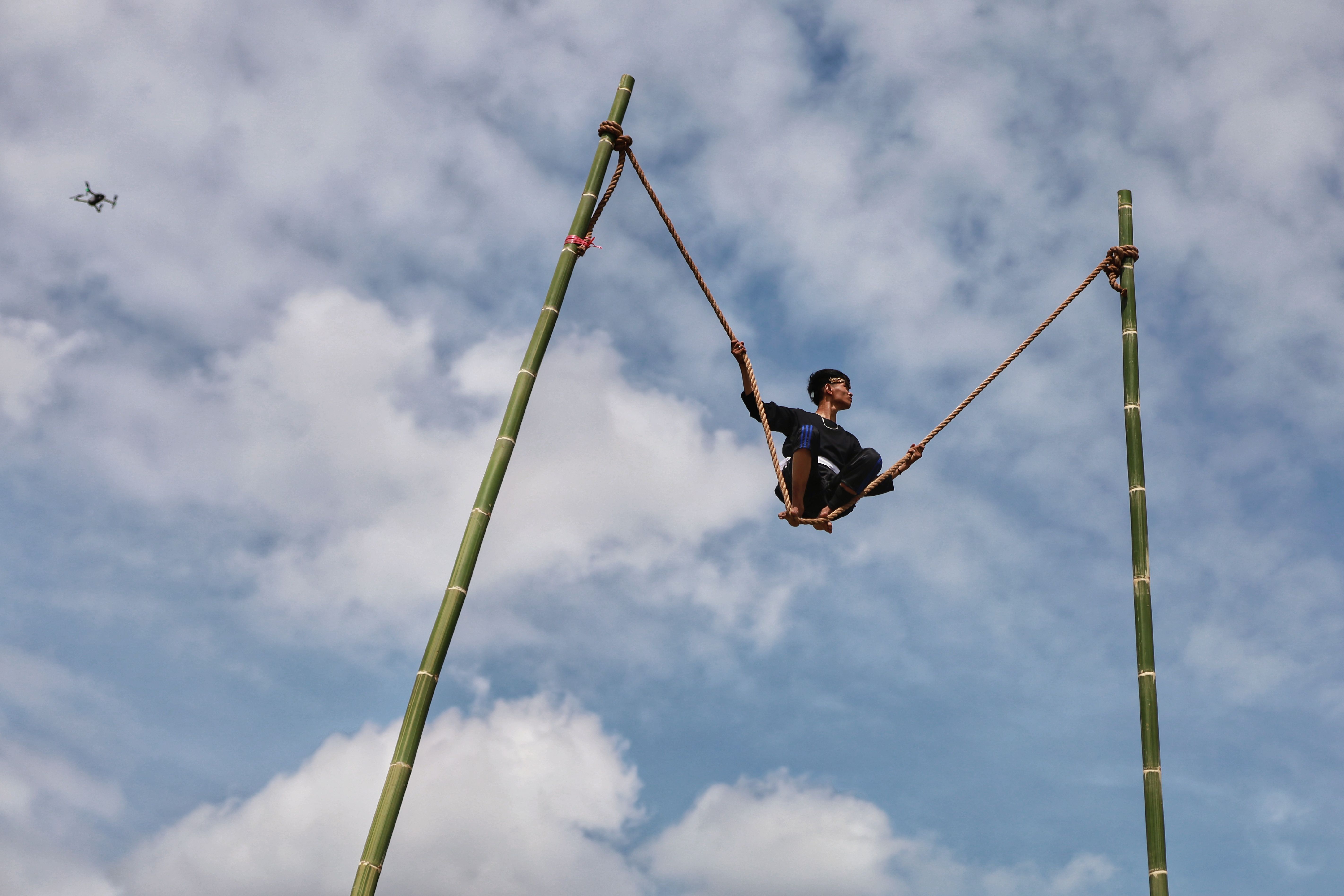 Man Swinging in Traditional Indonesian Bamboo Game · Free Stock Photo