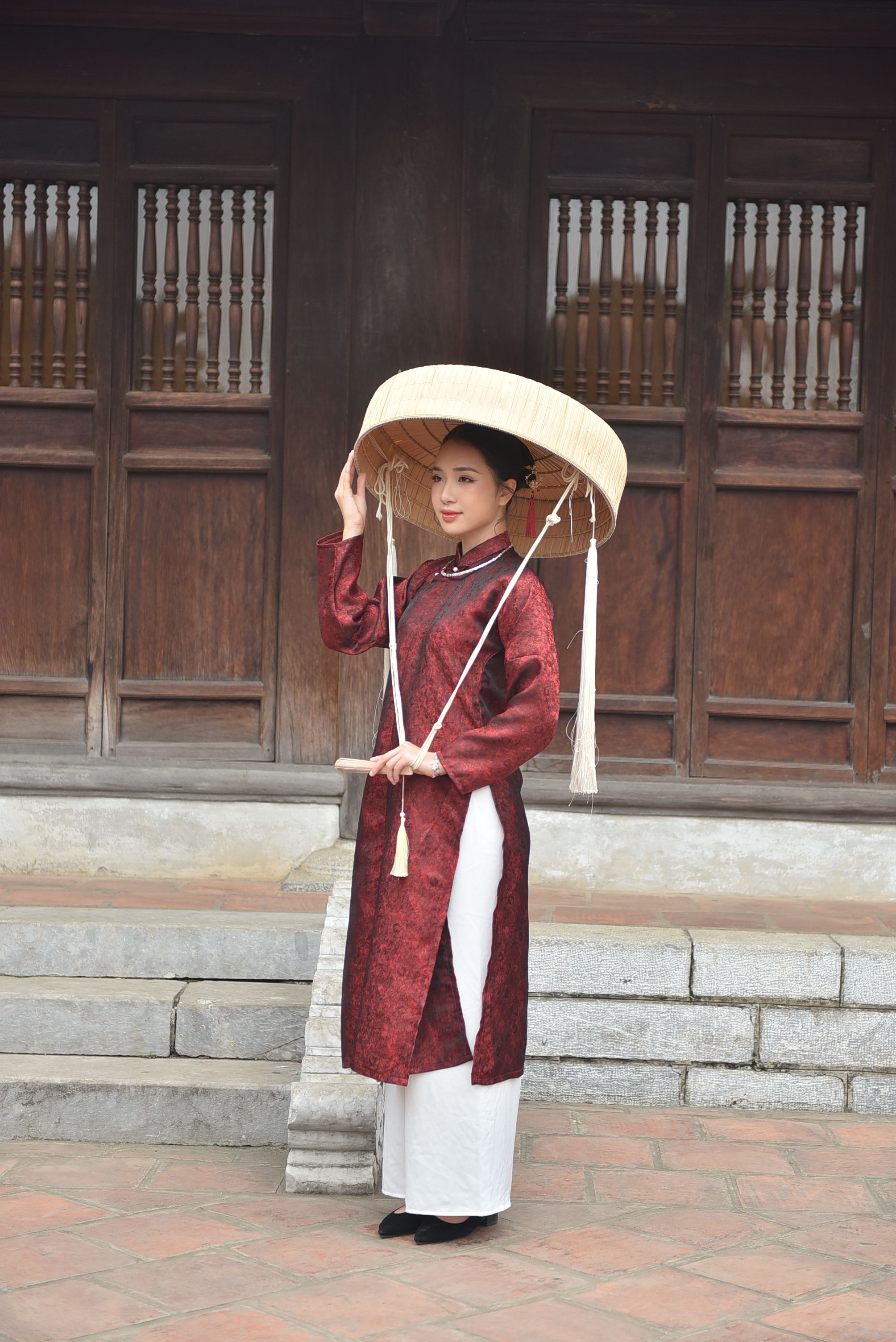 Traditional Asian Attire in Cultural Setting · Free Stock Photo