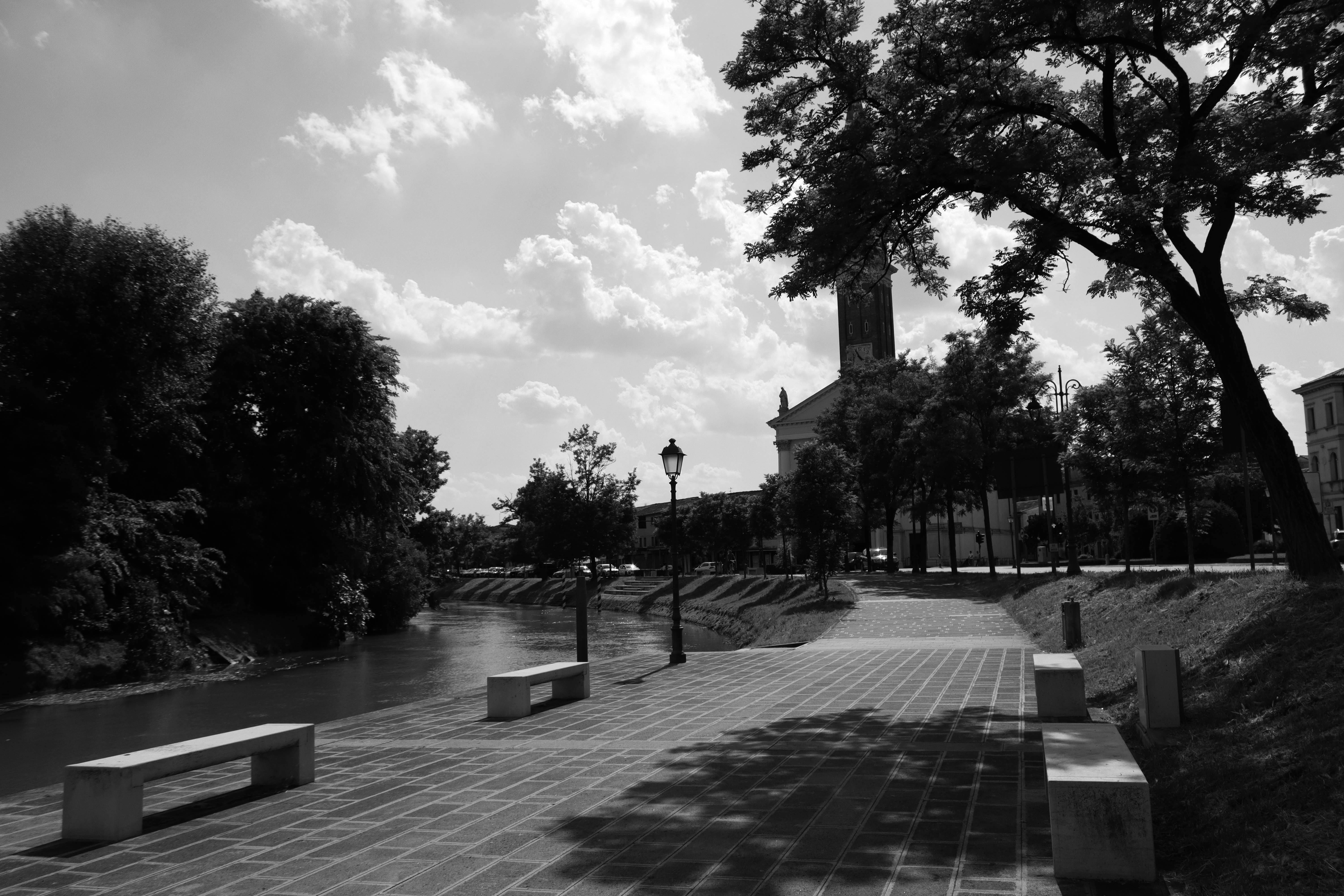 Scenic Riverside Pathway Under Dramatic Skies · Free Stock Photo
