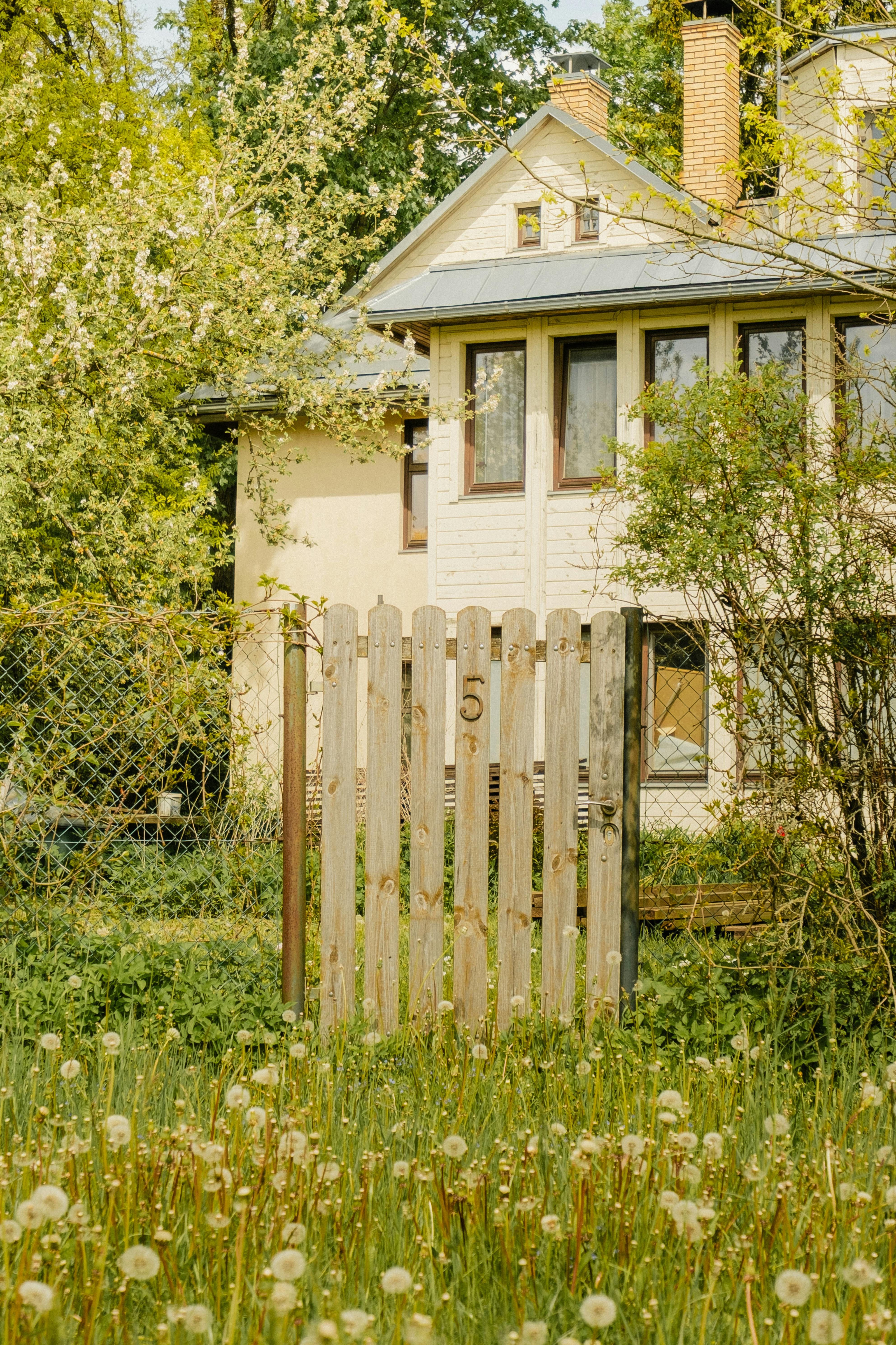 Charming House with Wooden Fence in Spring · Free Stock Photo