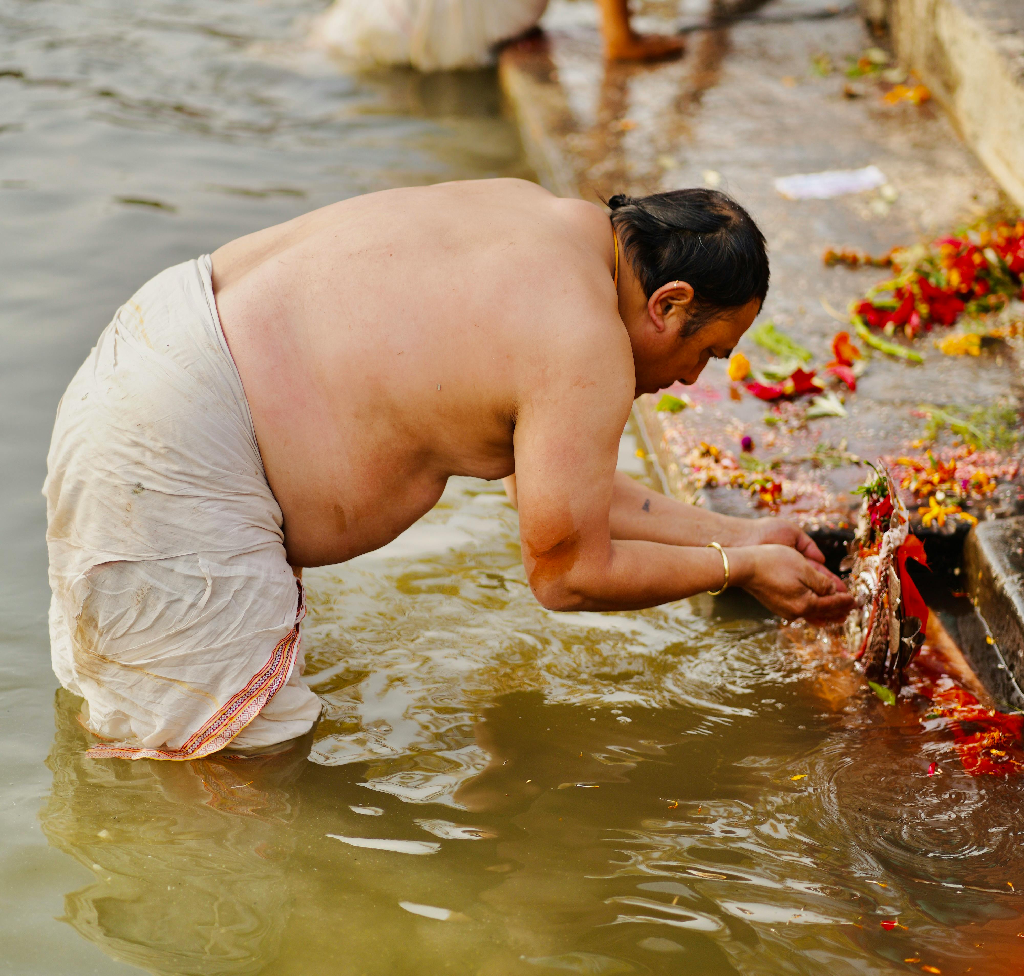 Hindu Devotee Performing Ritual in Sacred River · Free Stock Photo