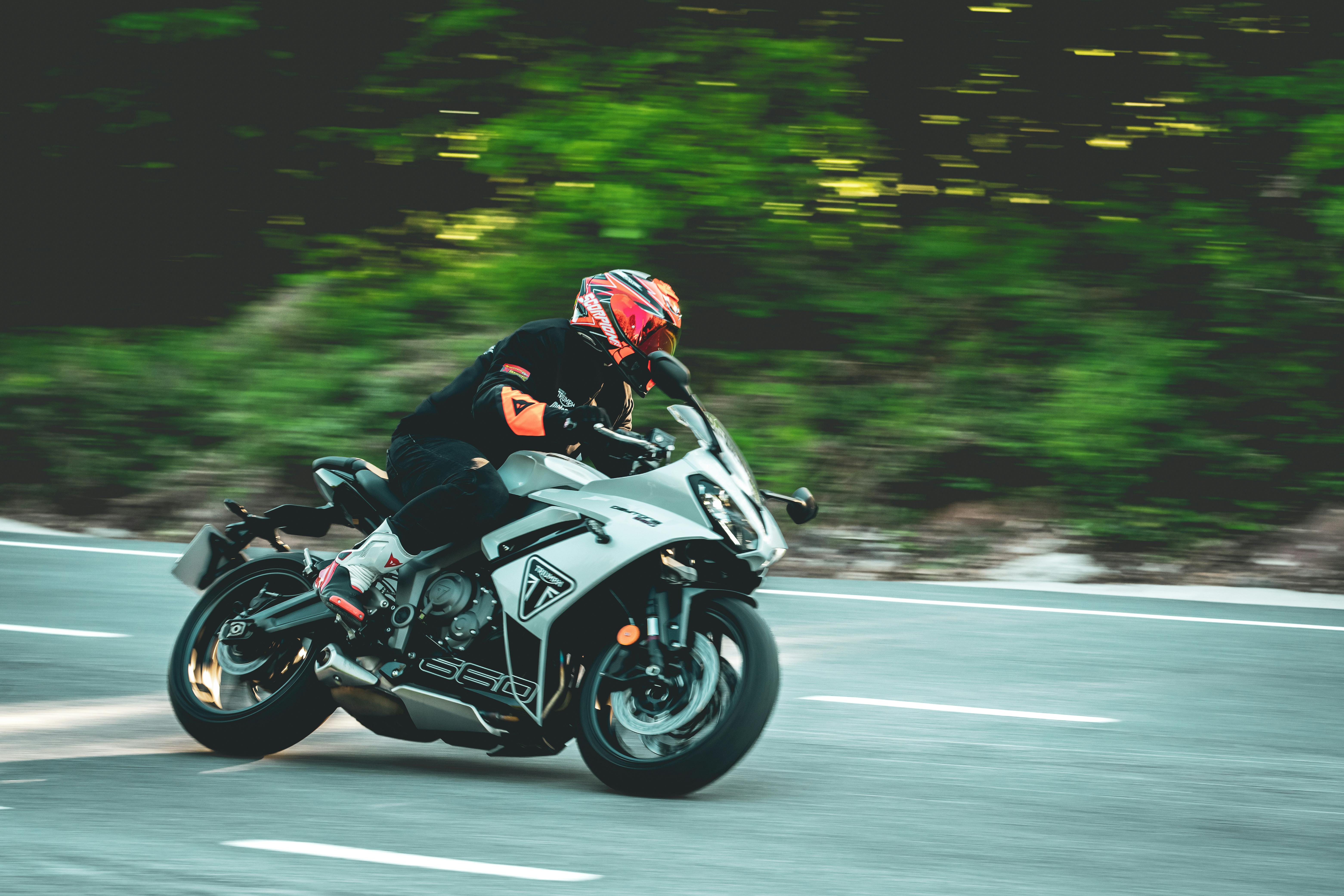 High-speed motorcycle racing on a road · Free Stock Photo