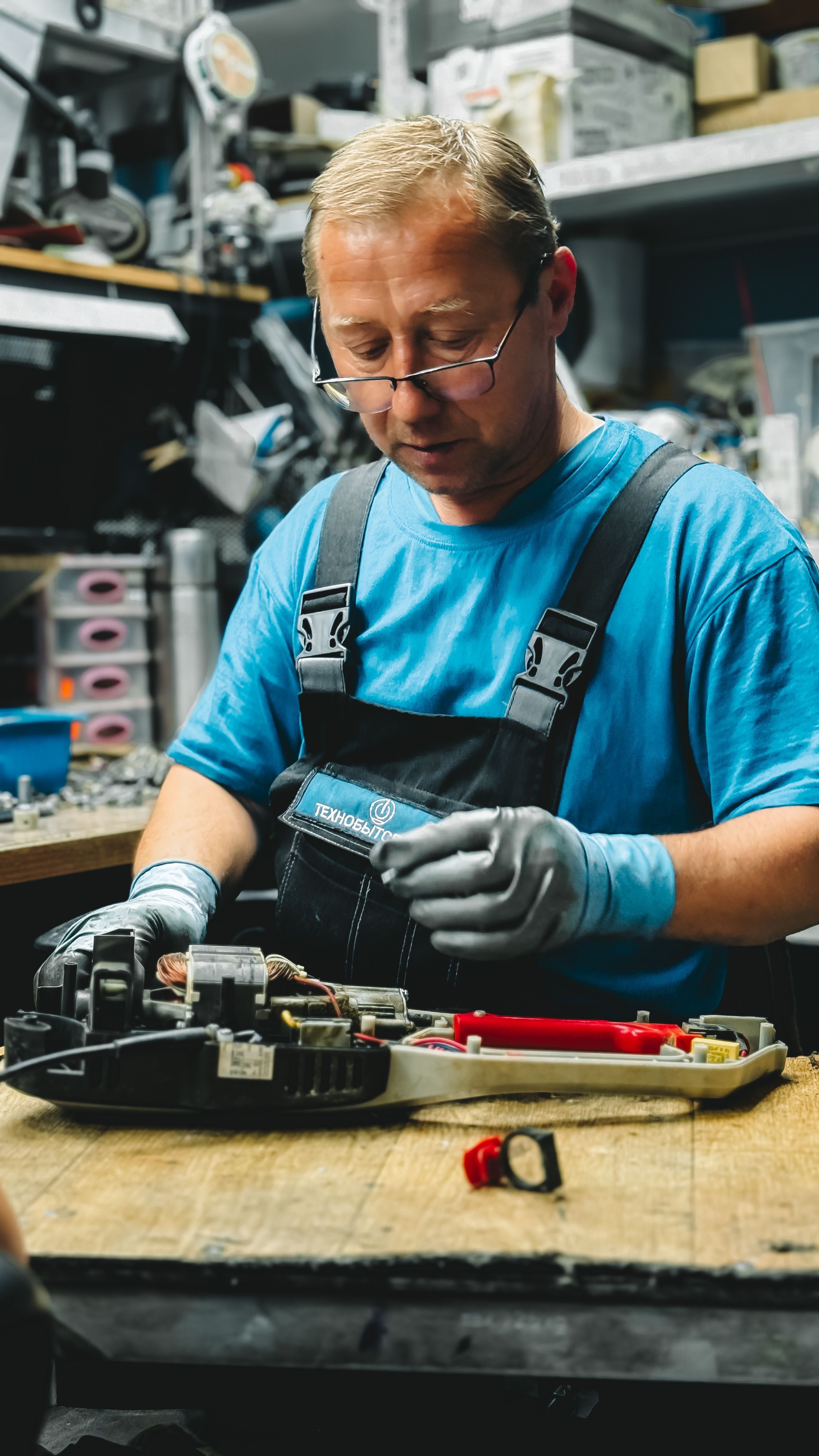 Mechanic Repairing Machinery in Workshop · Free Stock Photo