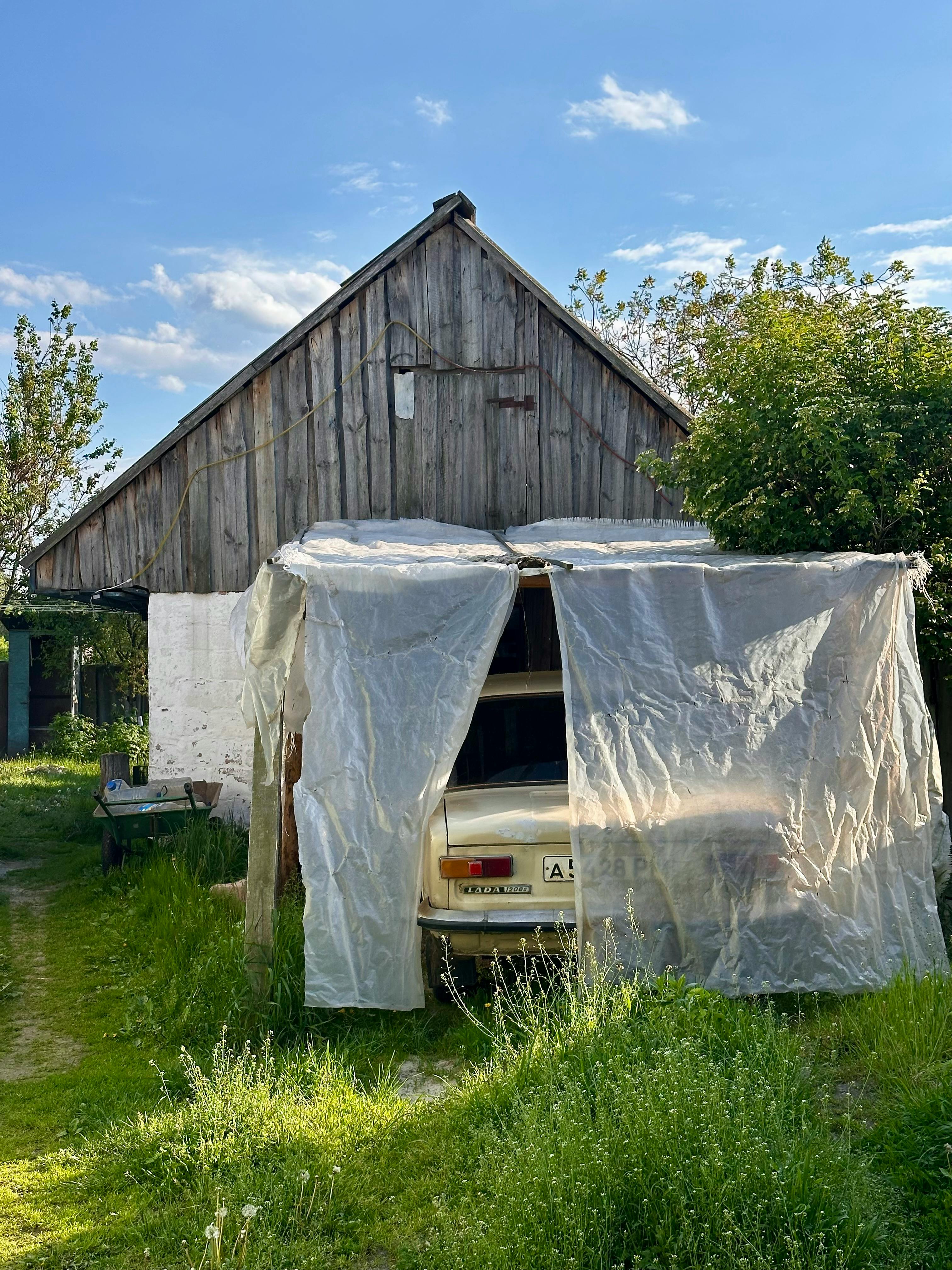 Rustic Barn with Car Covered by Tarp · Free Stock Photo