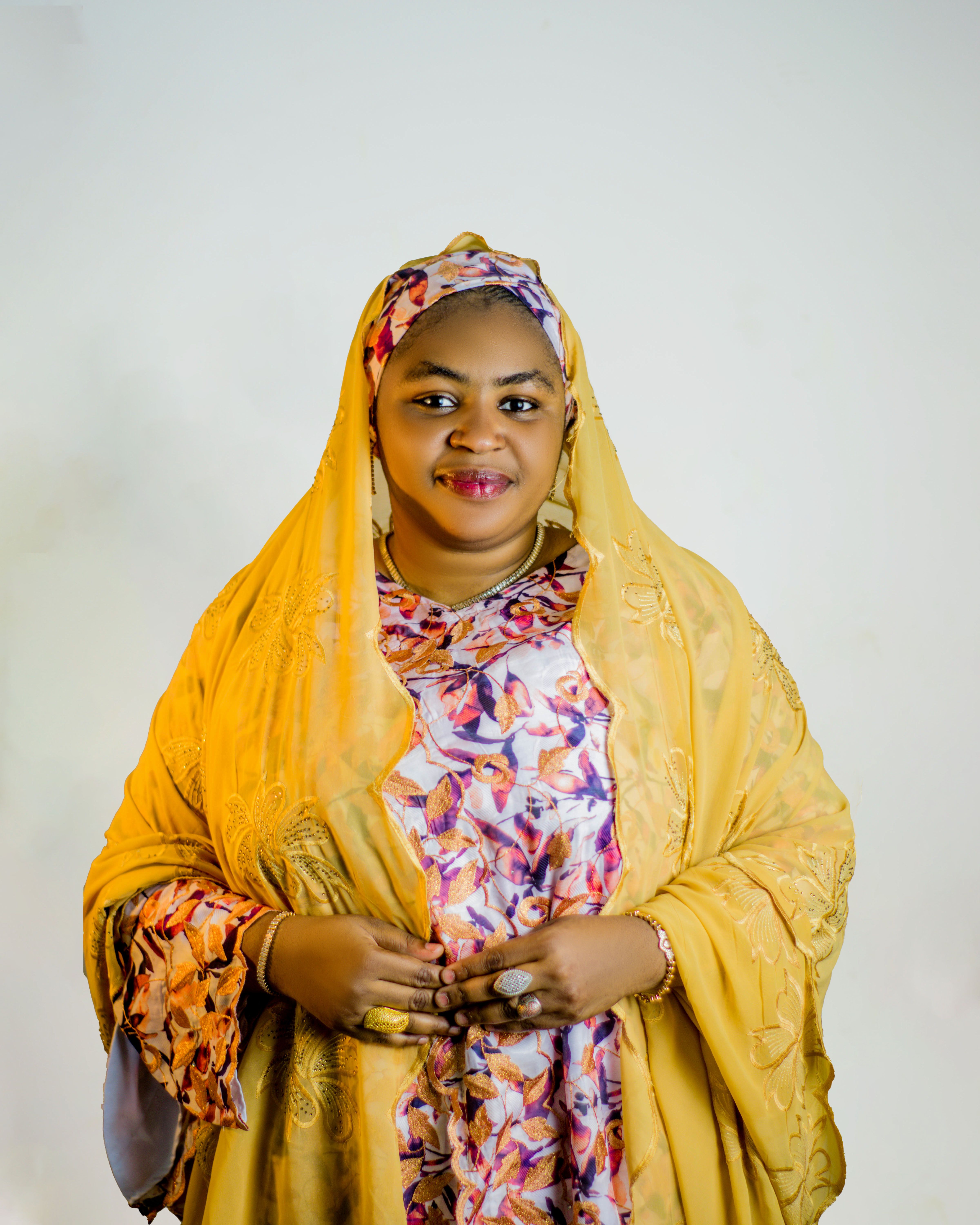 Portrait of a Woman in Traditional Yellow Attire · Free Stock Photo