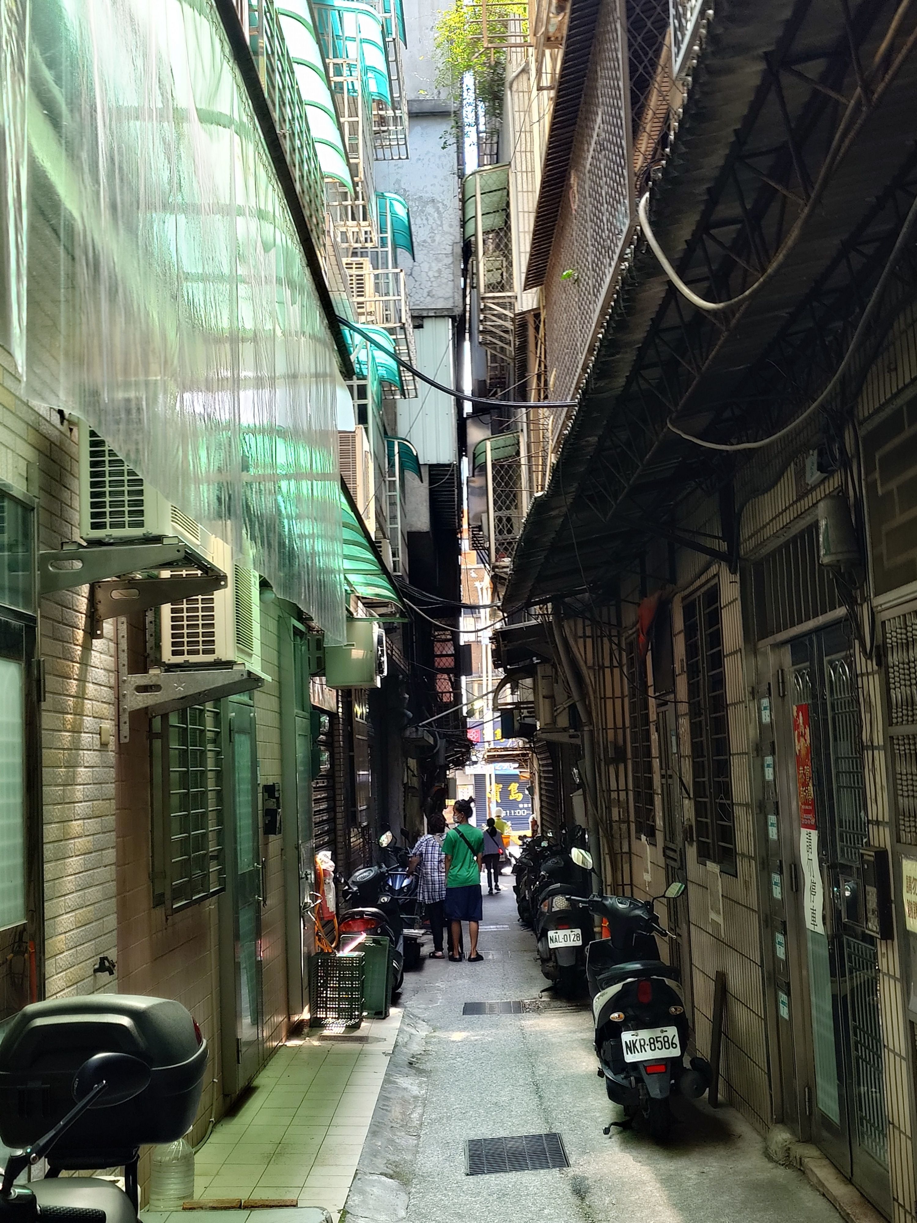 Narrow City Alley with Scooters and People · Free Stock Photo