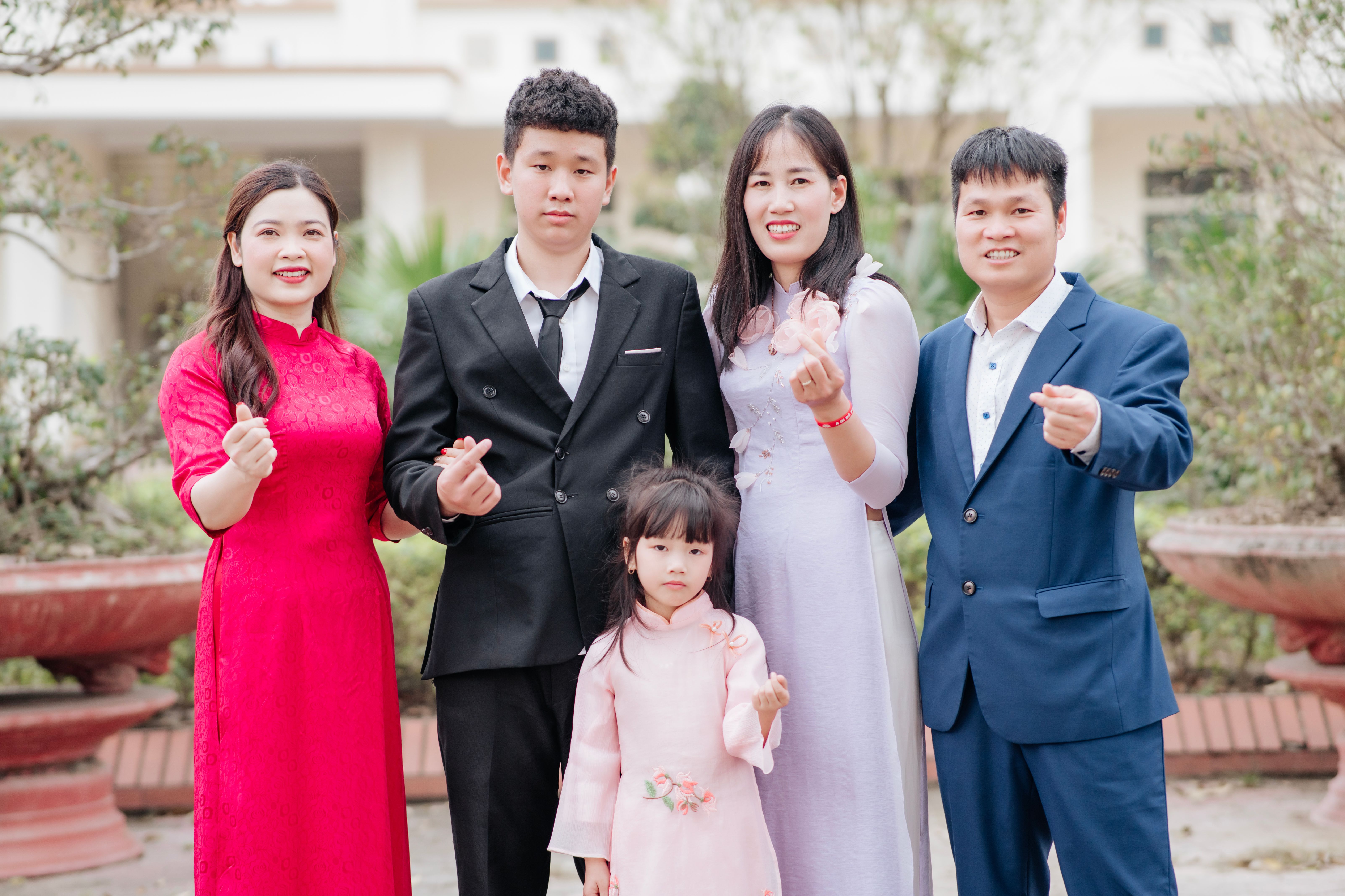 Happy Family Posing in Traditional Attire · Free Stock Photo