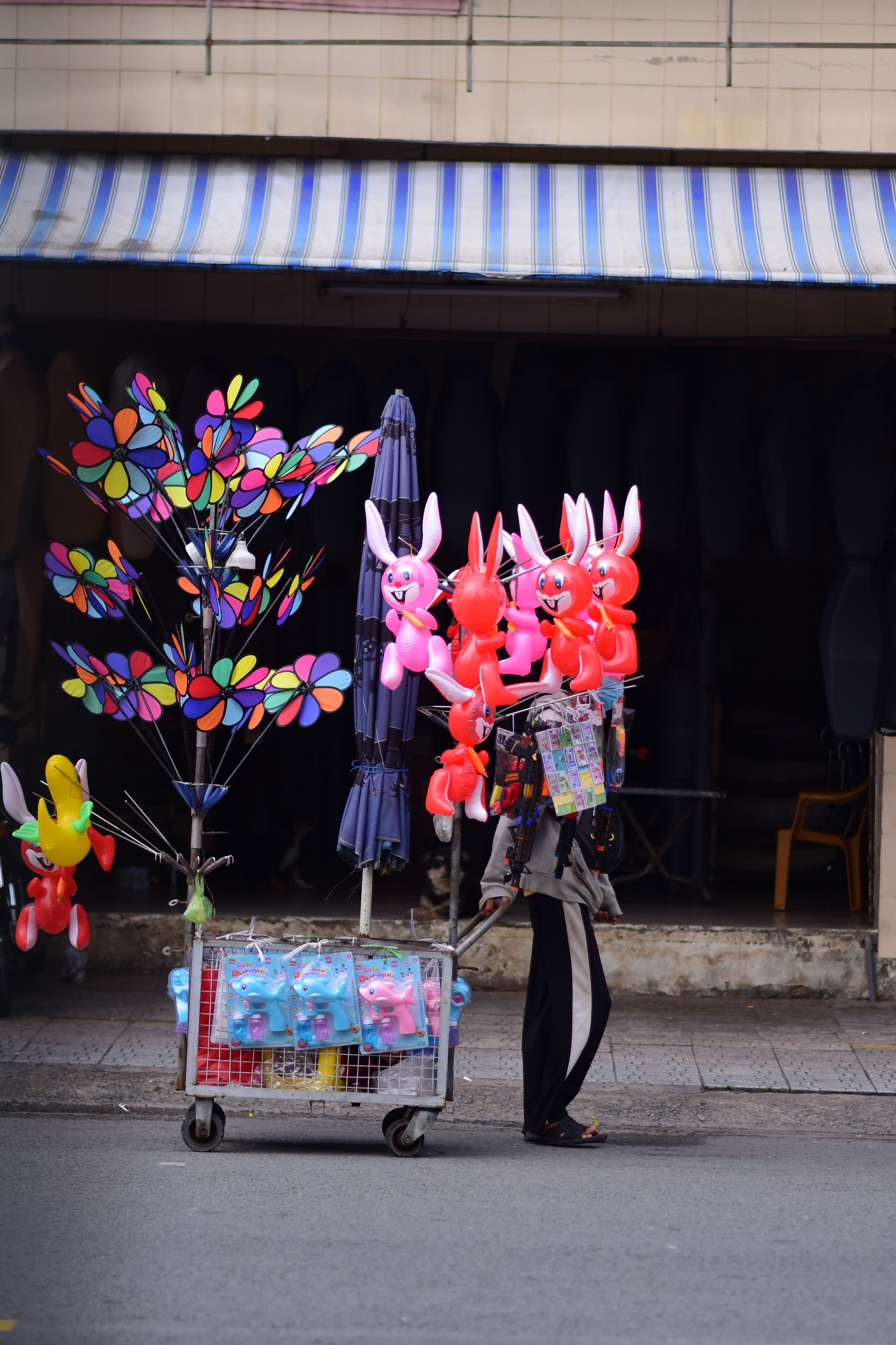 Street Vendor with Colorful Balloons and Toys in Urban Setting · Free ...