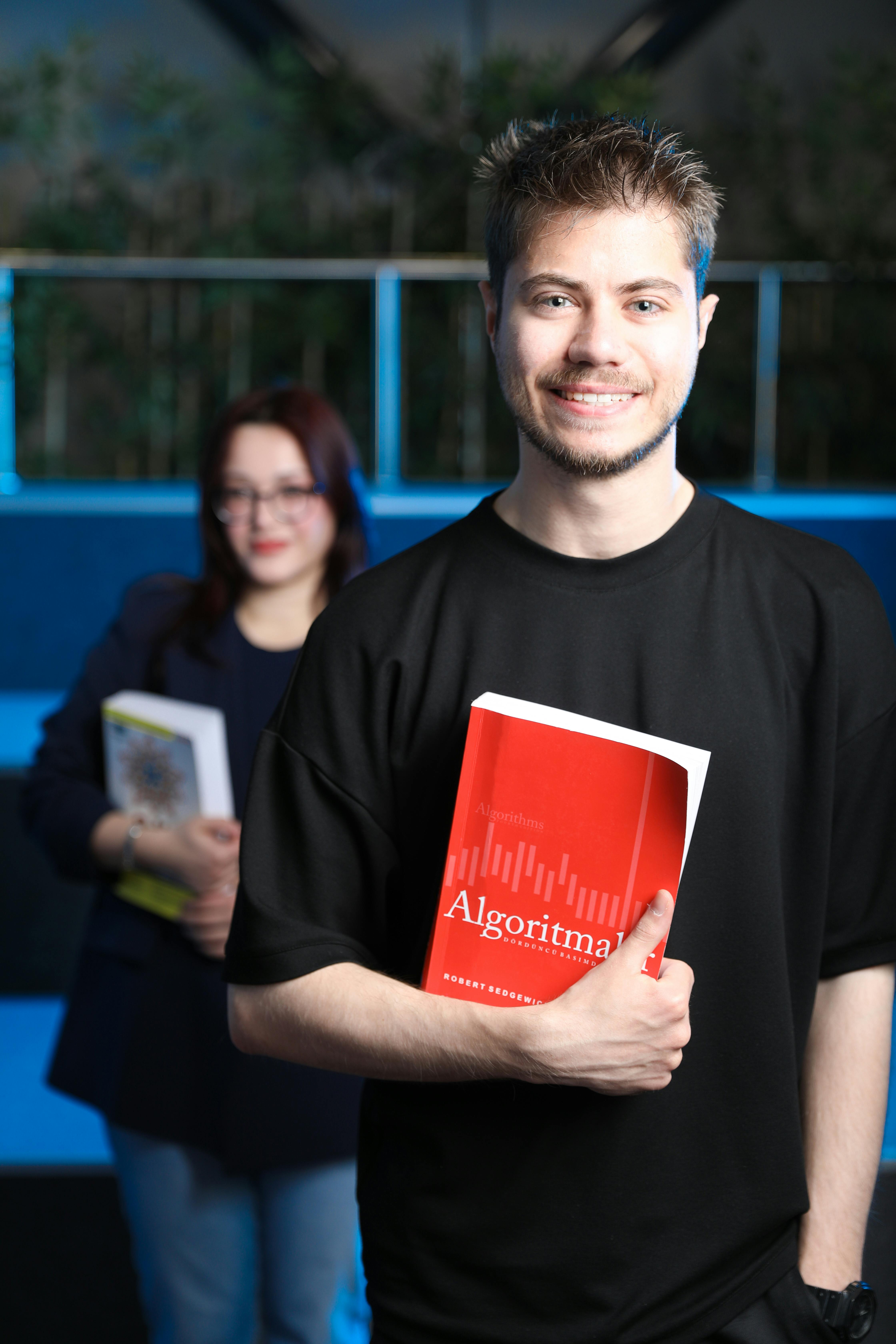 Young Professionals Holding Algorithm Books · Free Stock Photo