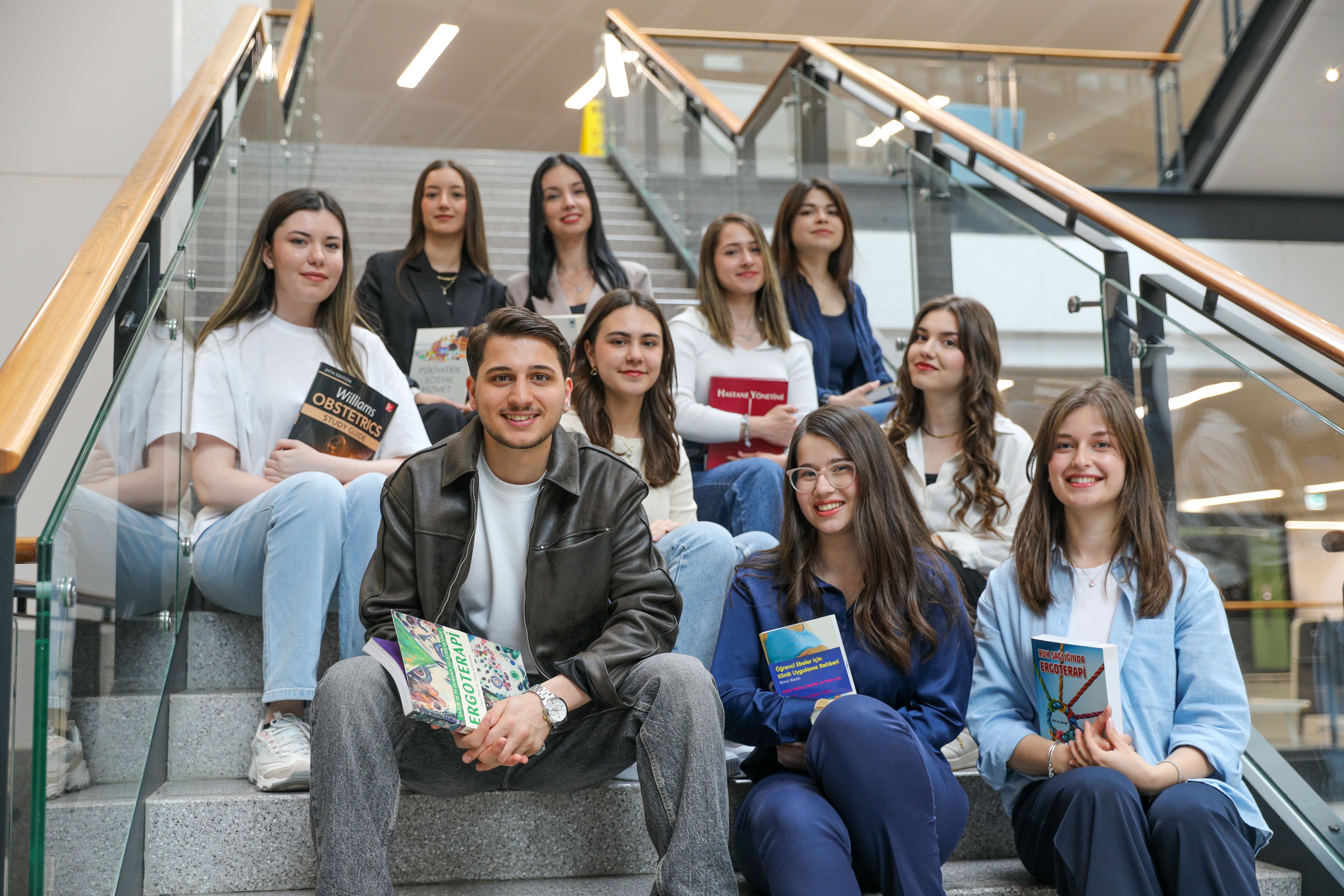 Diverse Group of Students Holding Books on Campus · Free Stock Photo