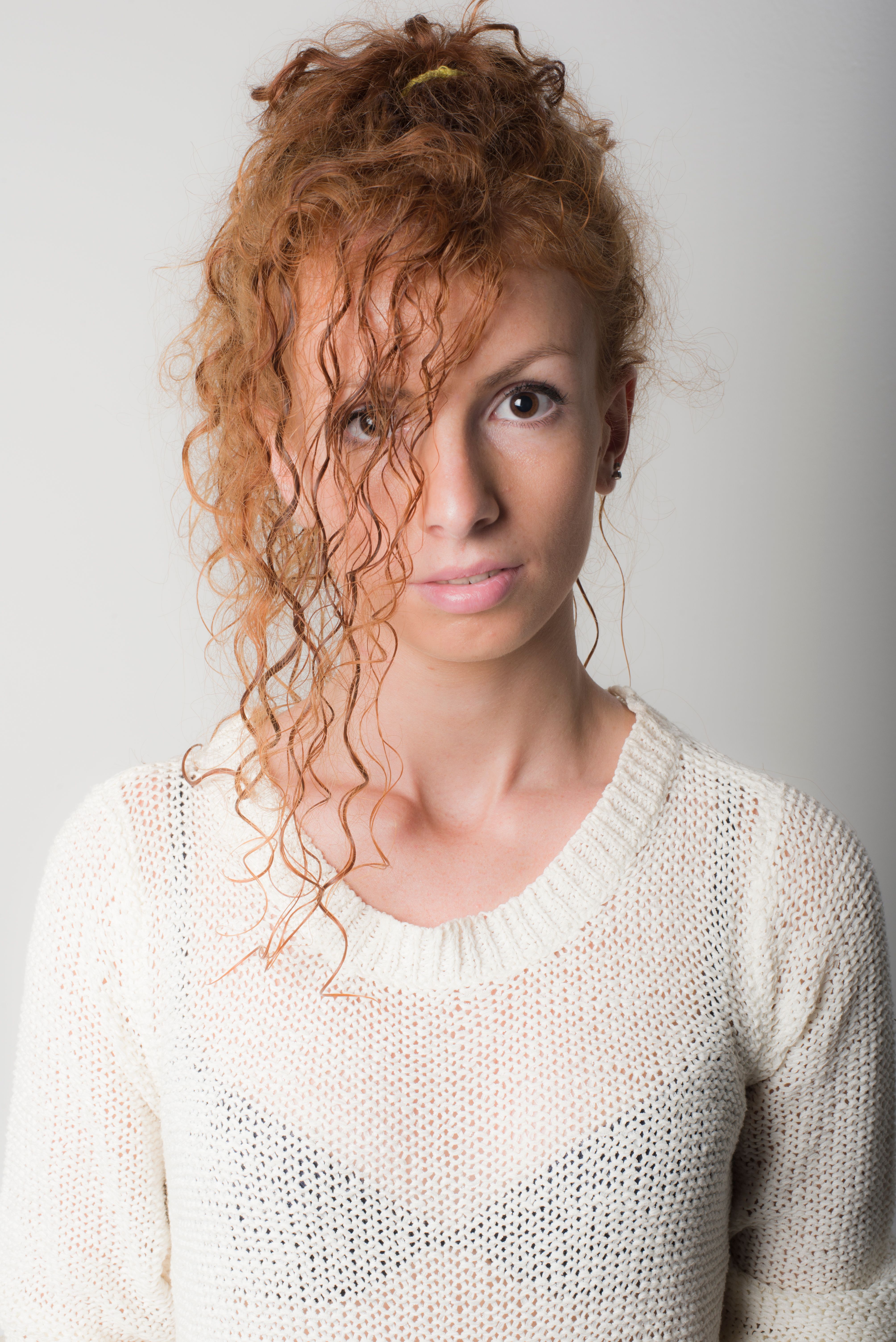 Portrait of a Young Woman with Curly Red Hair · Free Stock Photo