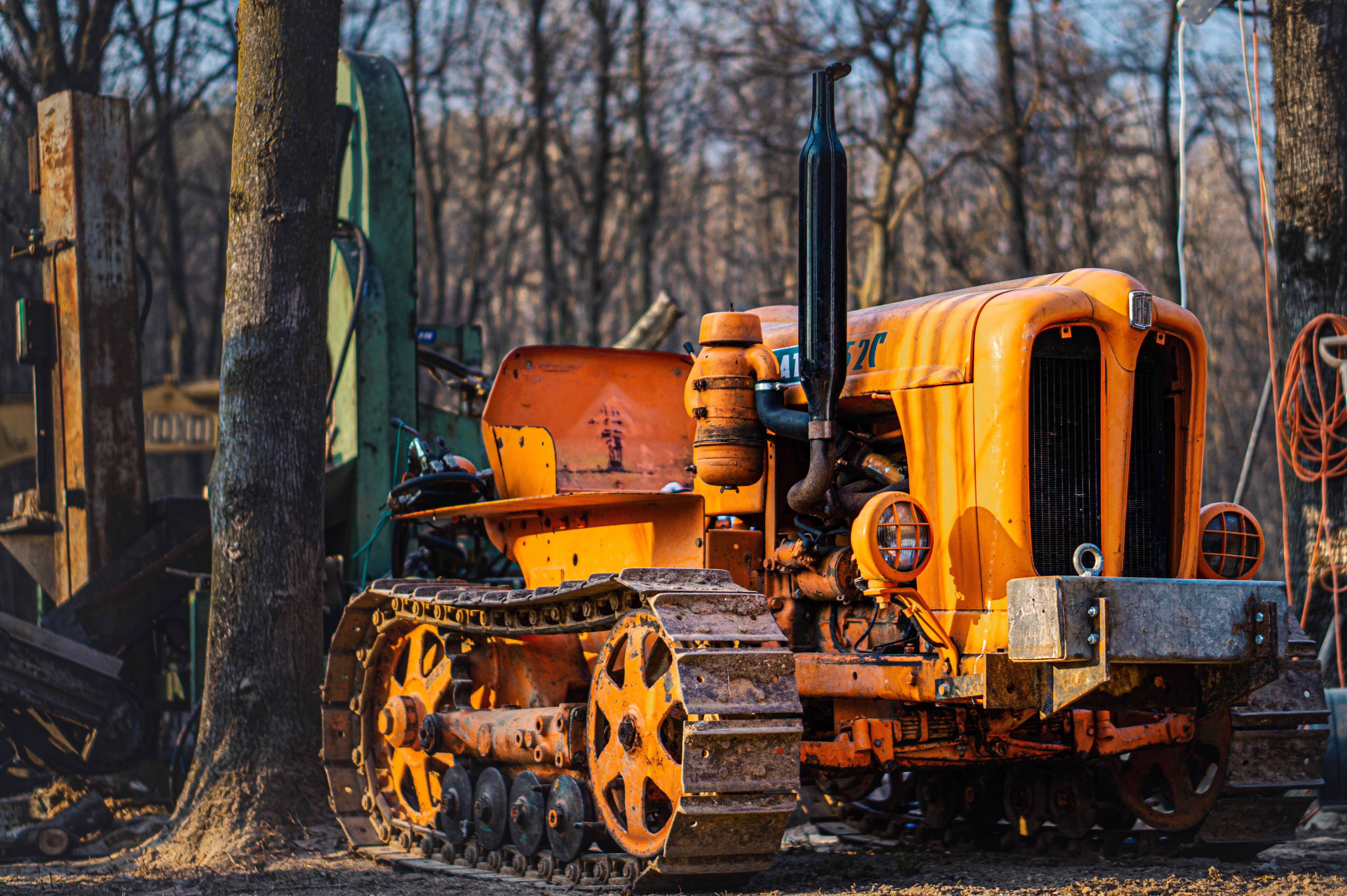 Vintage Orange Tractor in European Forest Setting · Free Stock Photo