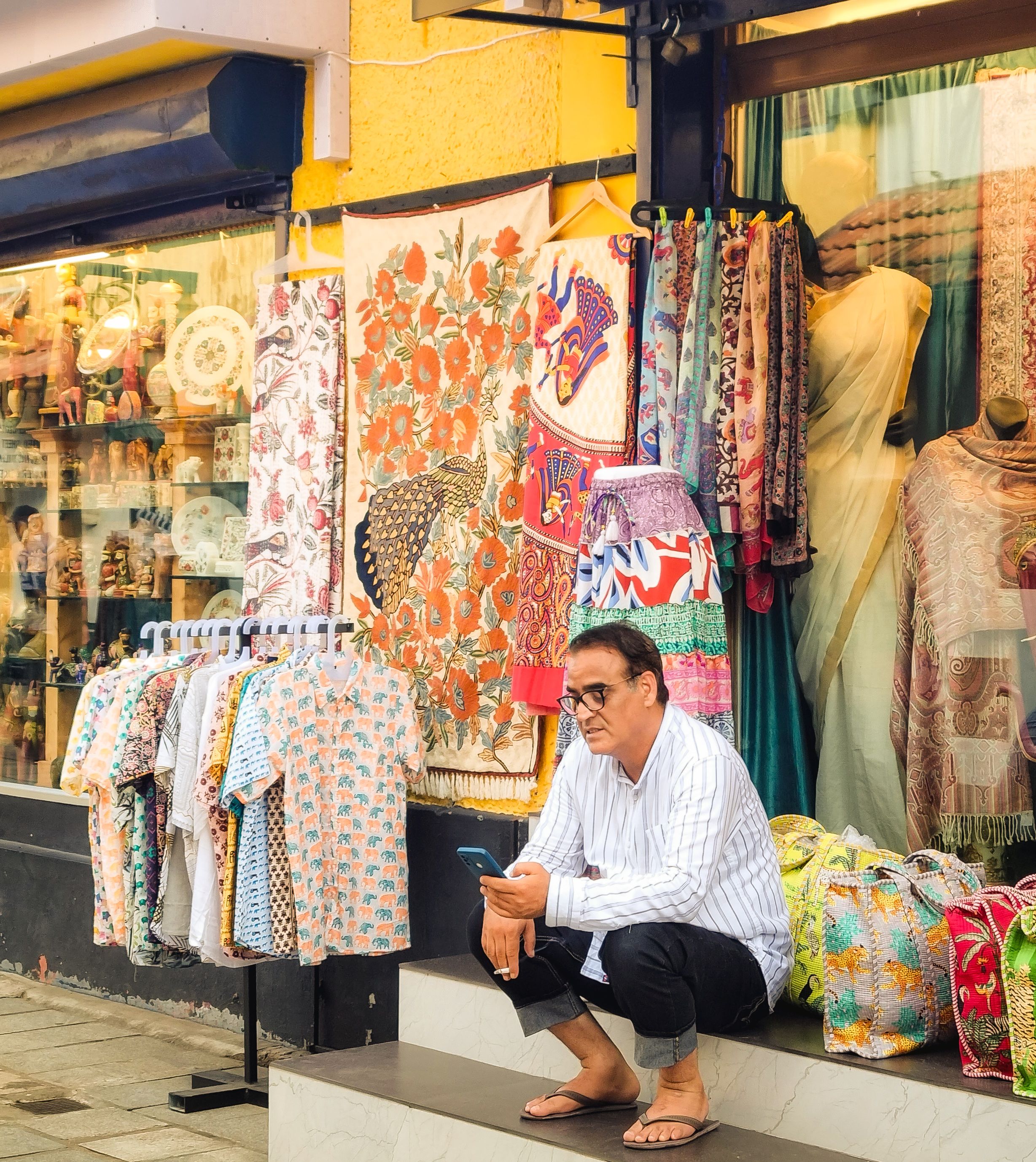 Colorful Textile Market Stall with Local Vendor · Free Stock Photo