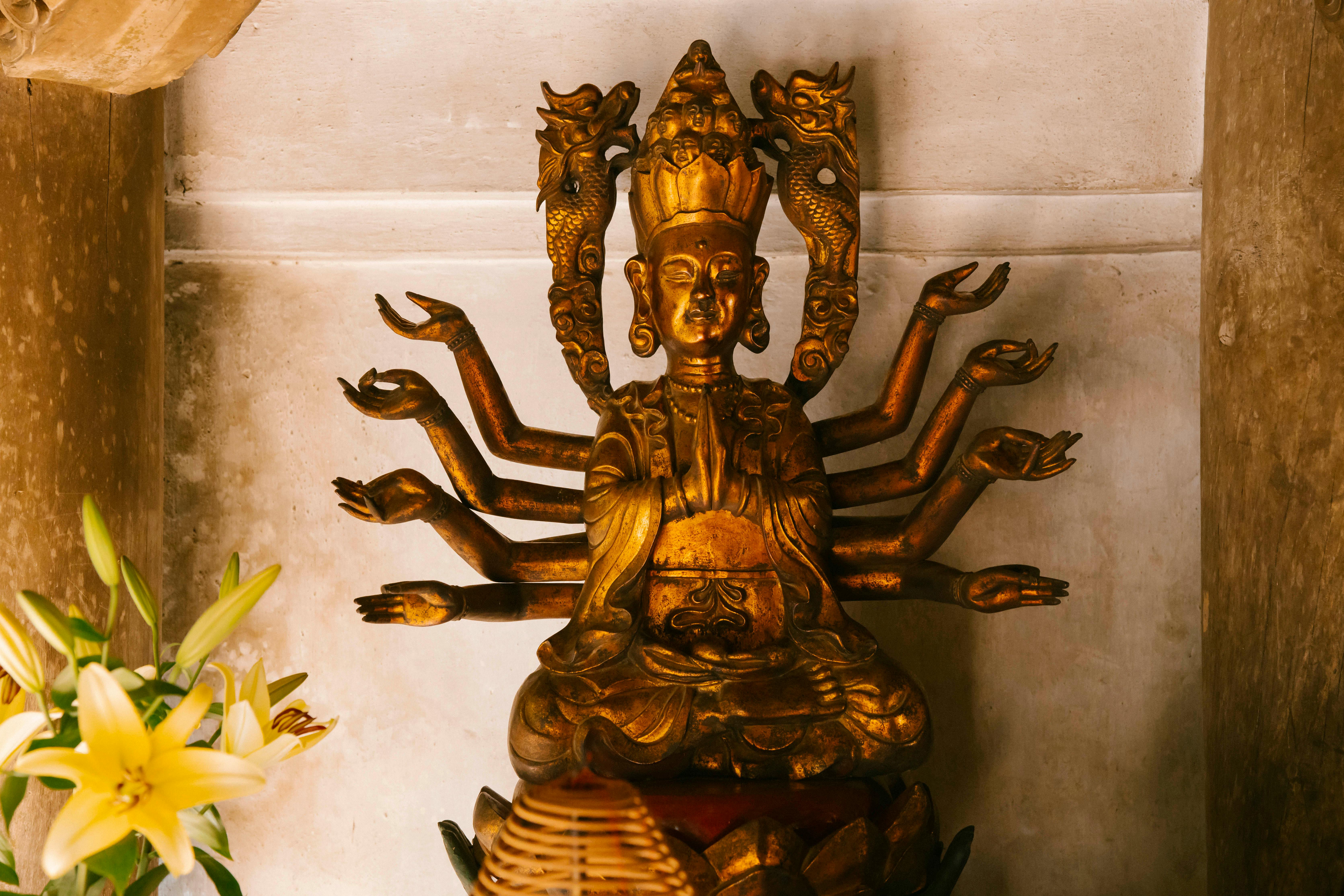 Golden Multi-Armed Statue in Ancient Temple · Free Stock Photo