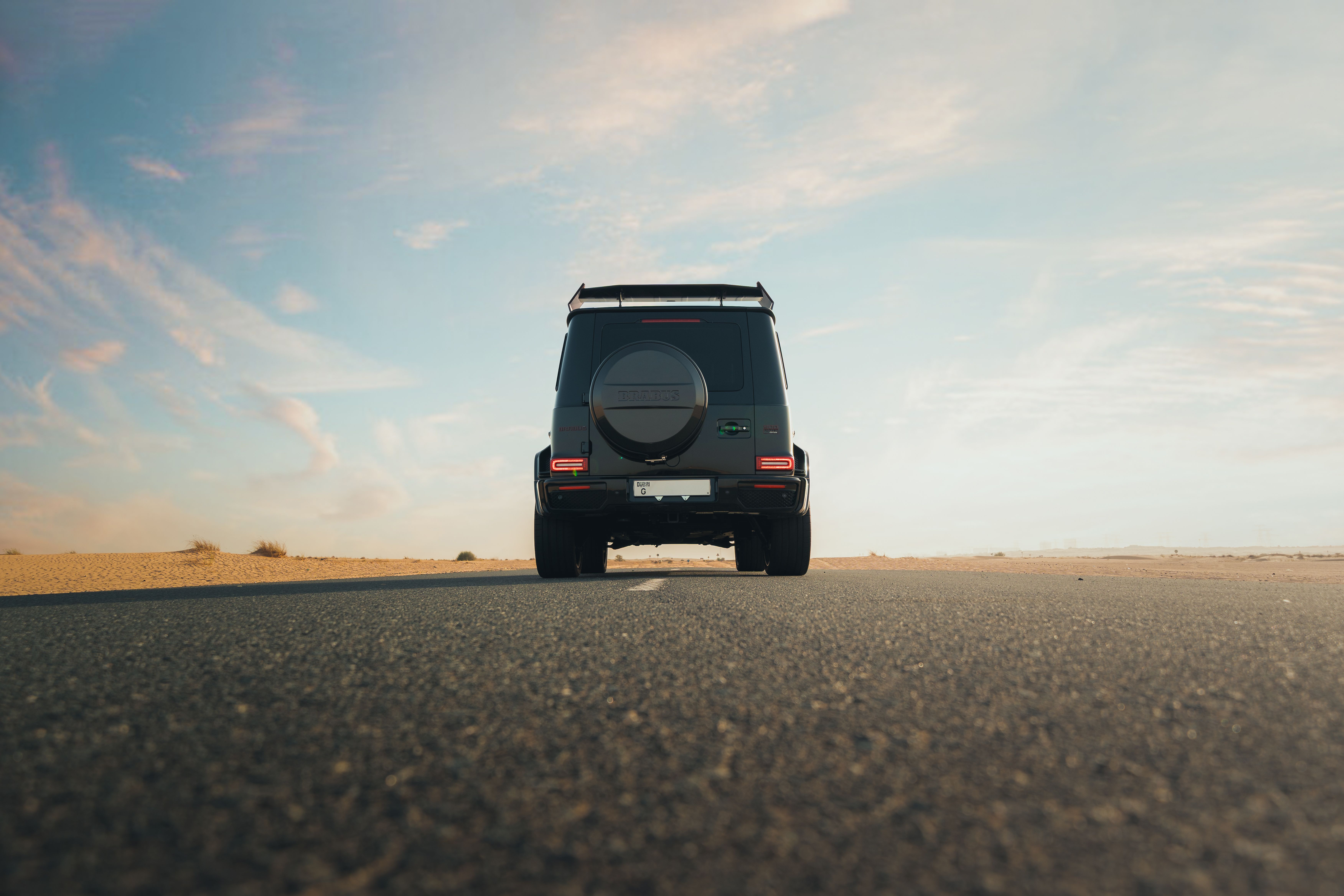 Luxury SUV on Open Desert Road During Daytime · Free Stock Photo