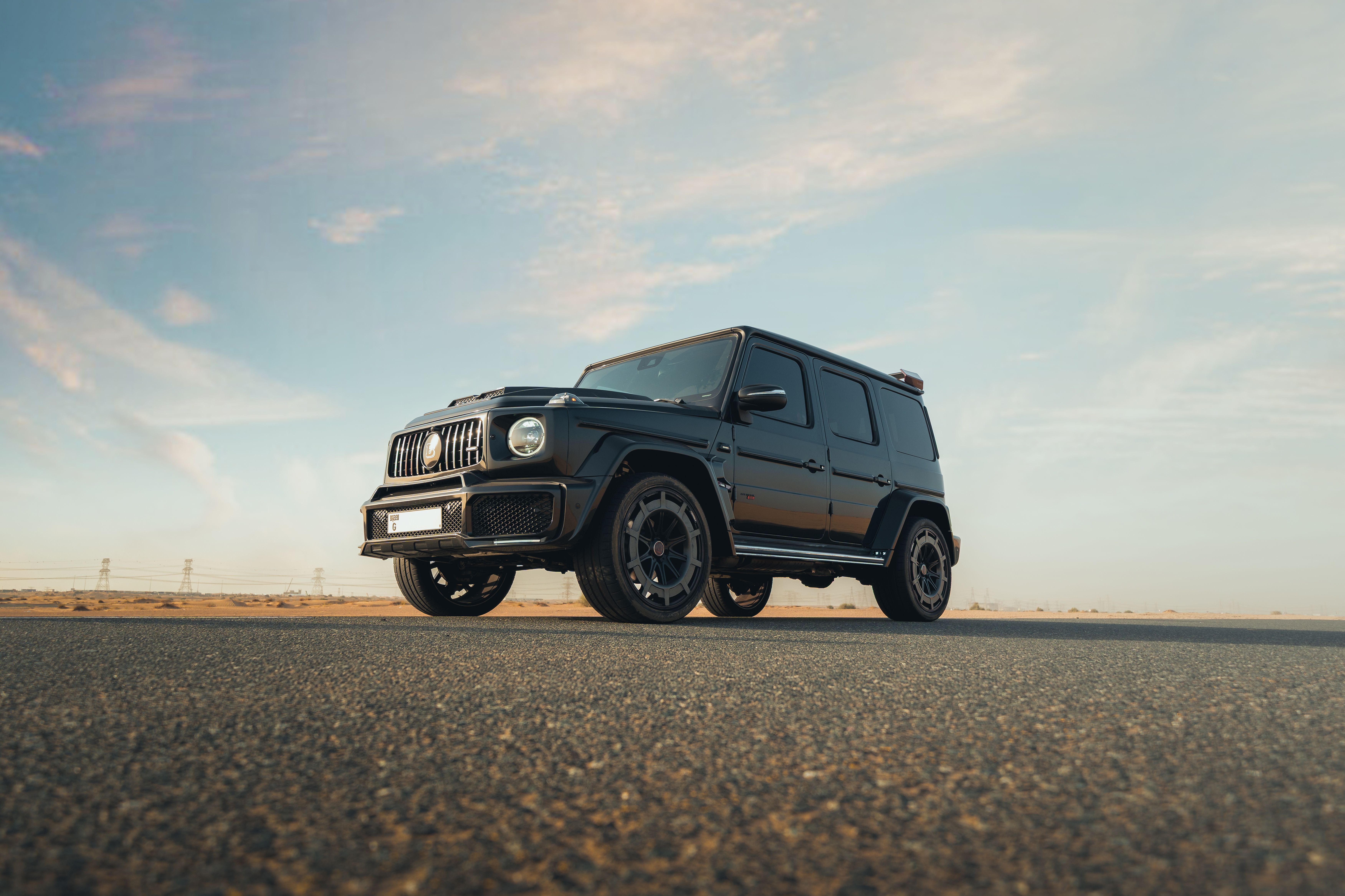 Luxury SUV on Open Desert Road at Dusk · Free Stock Photo