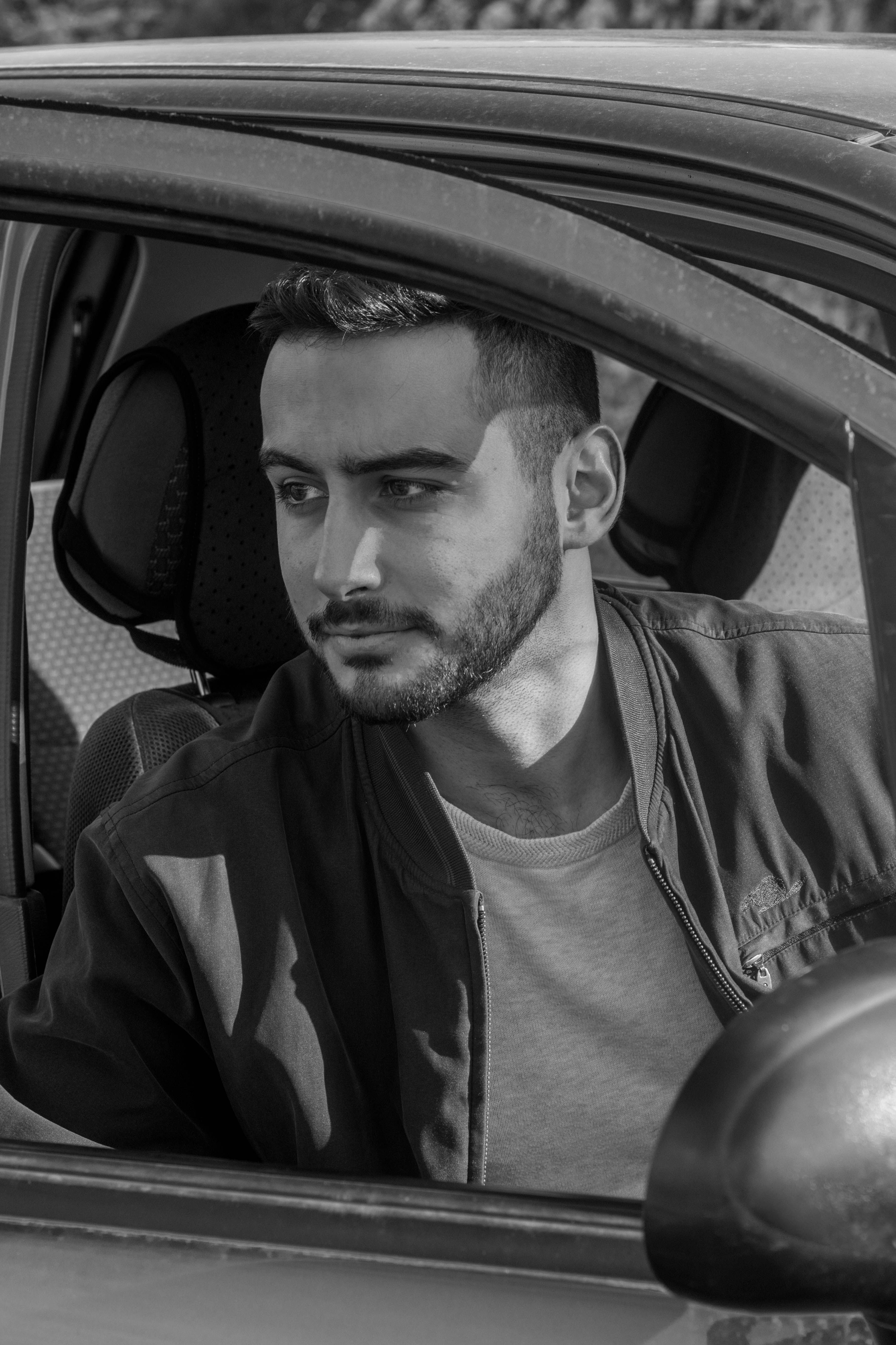 Black and White Portrait of Man in Car · Free Stock Photo