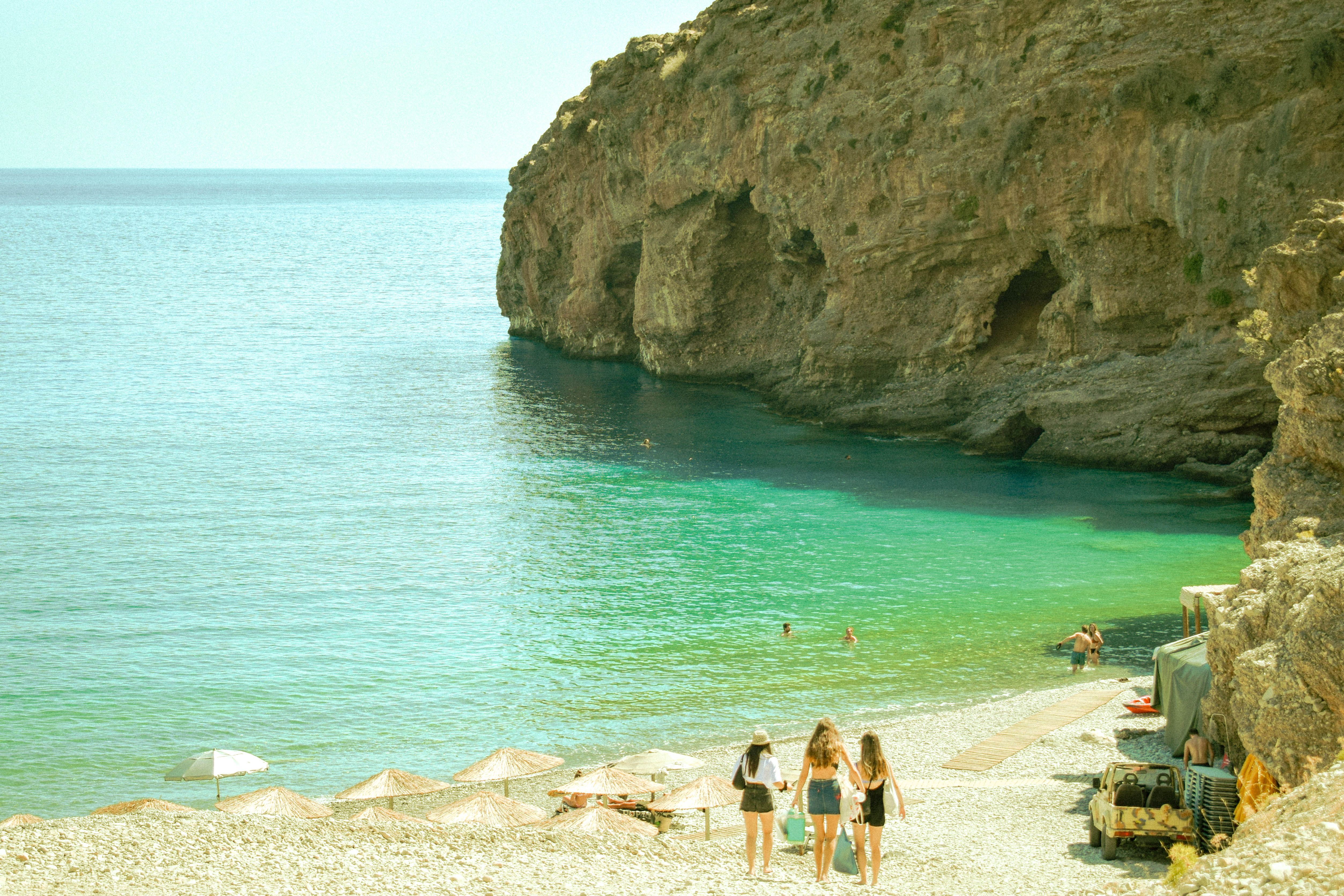 Scenic Summer Beach with Rocky Cliffs in Greece · Free Stock Photo