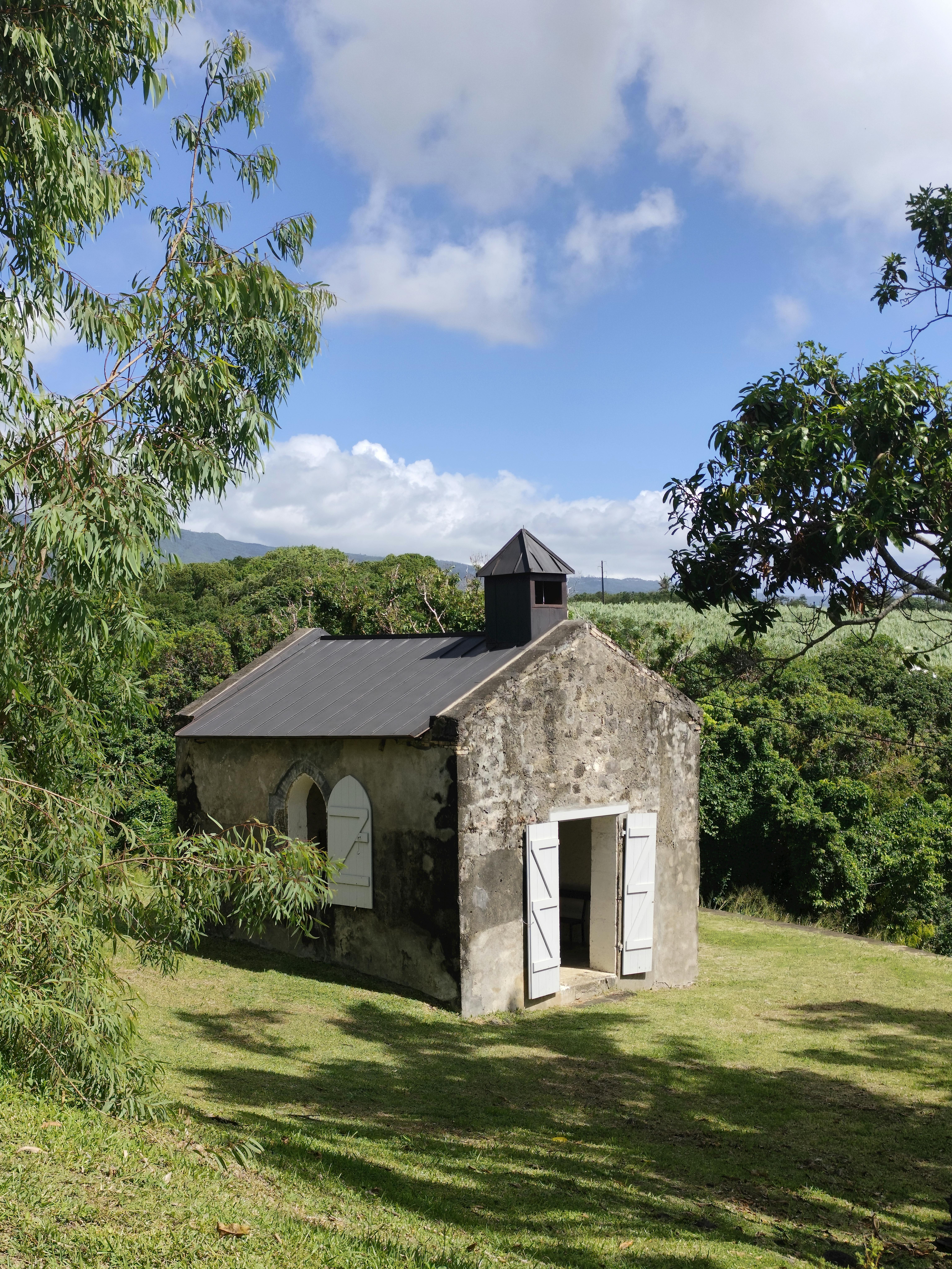 Rustic Stone Building in Lush Green Landscape · Free Stock Photo