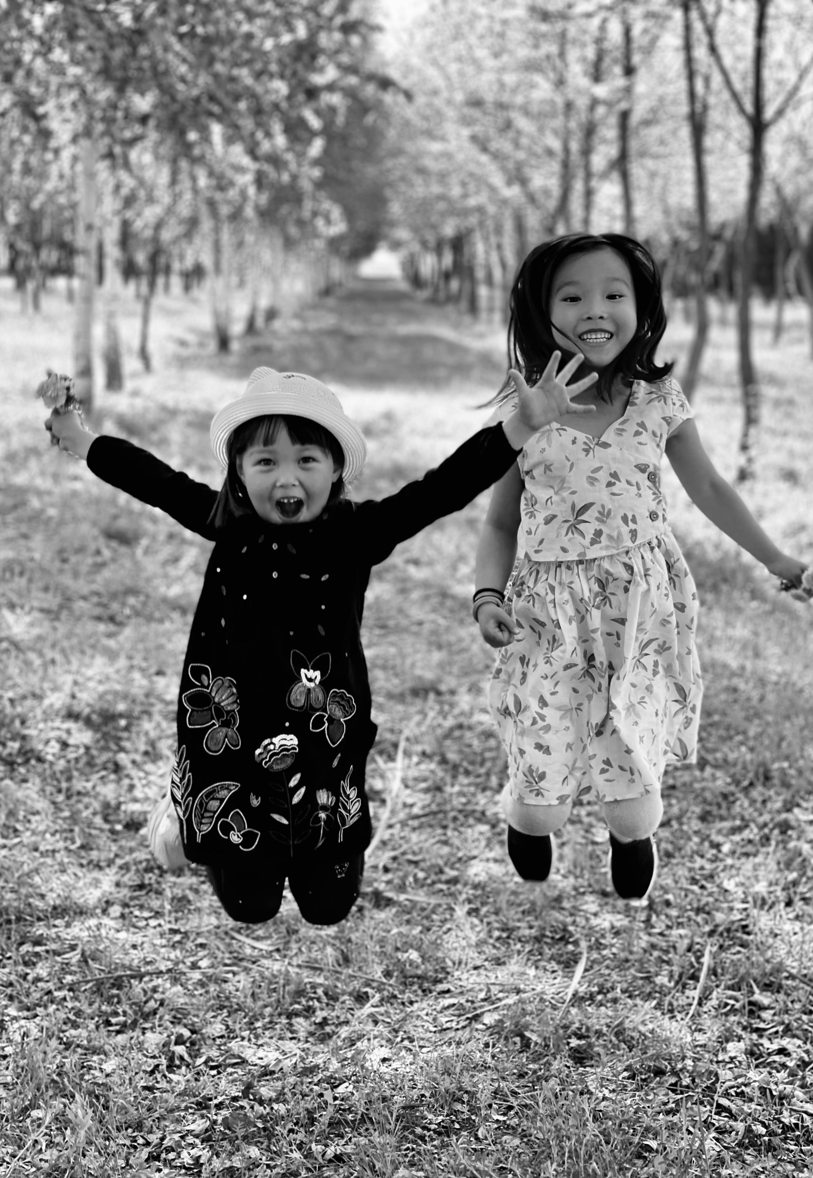 Joyful Children Jumping in Spring Orchard · Free Stock Photo