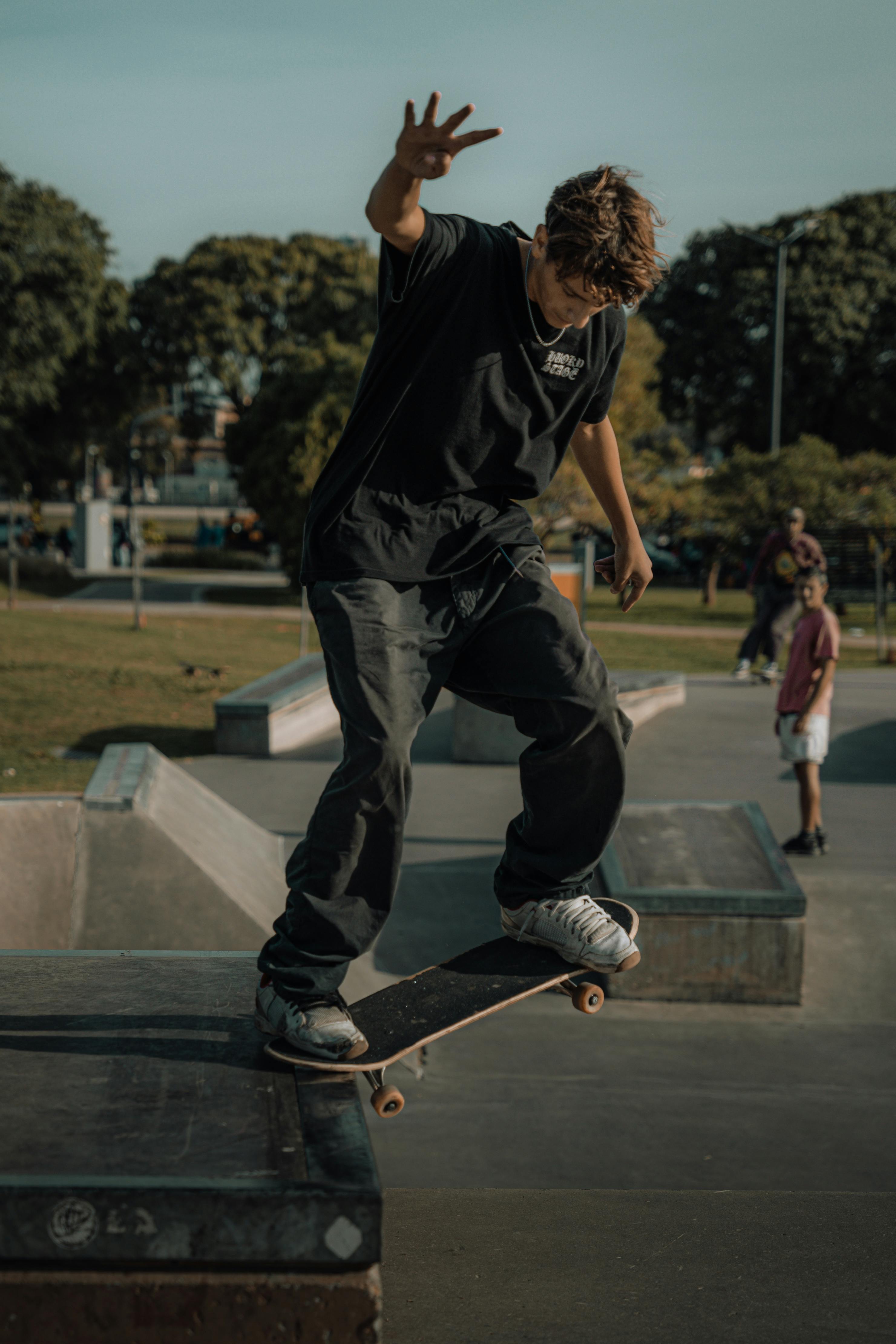 Teen Skateboarder Performing Trick at Urban Skatepark · Free Stock Photo