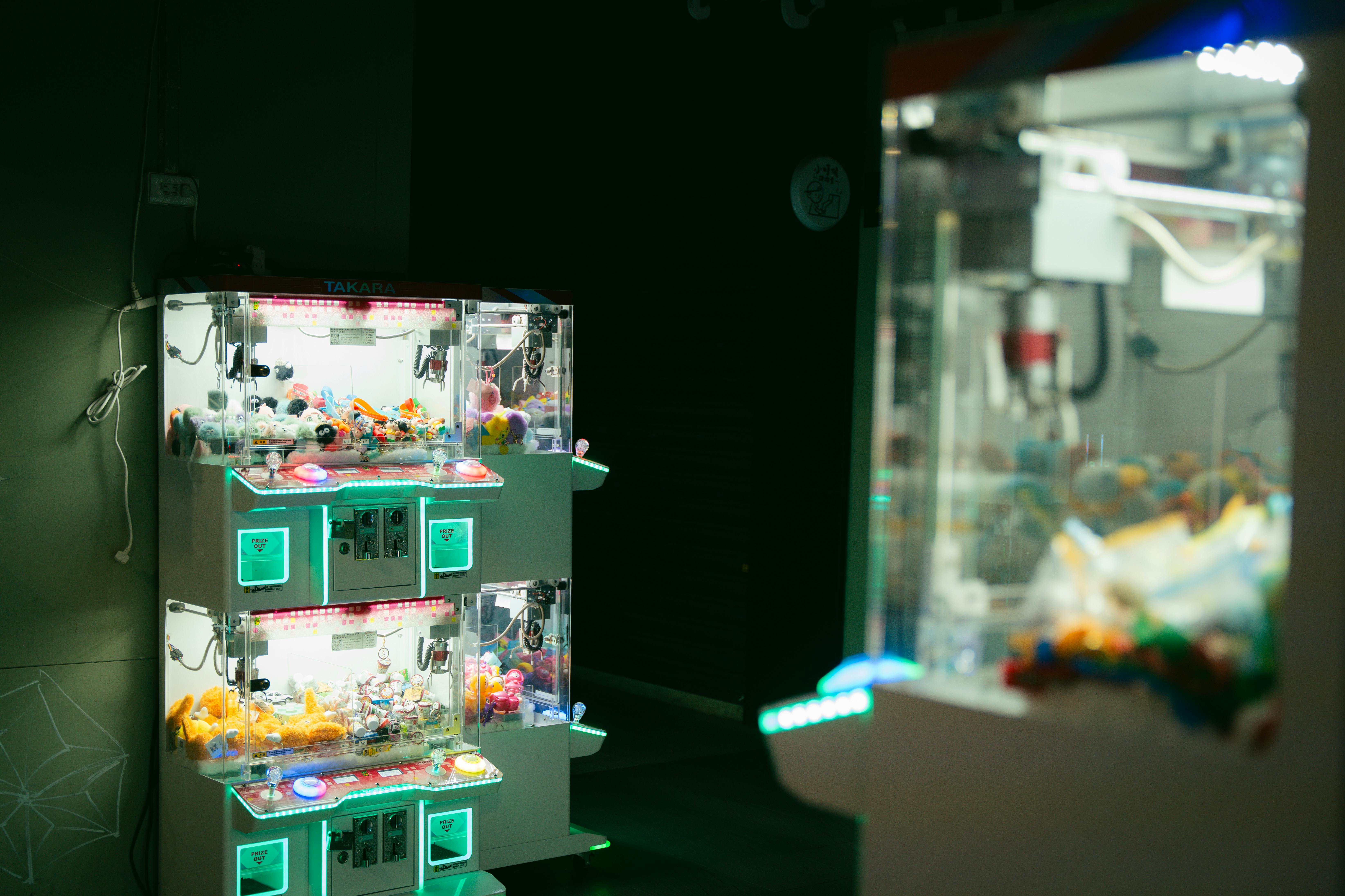 Arcade Claw Machines with Bright Neon Lights · Free Stock Photo