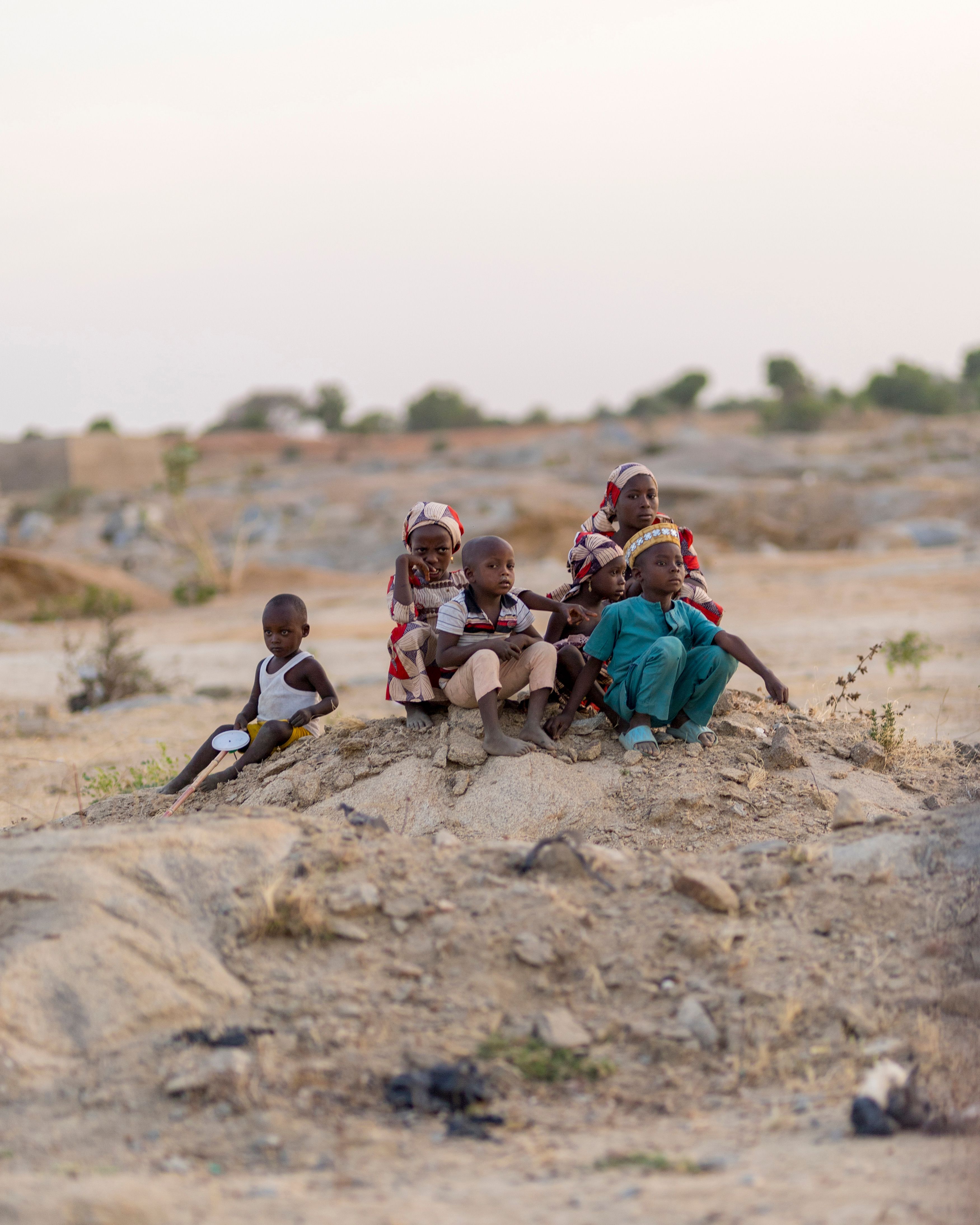 Group of Children Playing on Large Rocks Outdoors · Free Stock Photo
