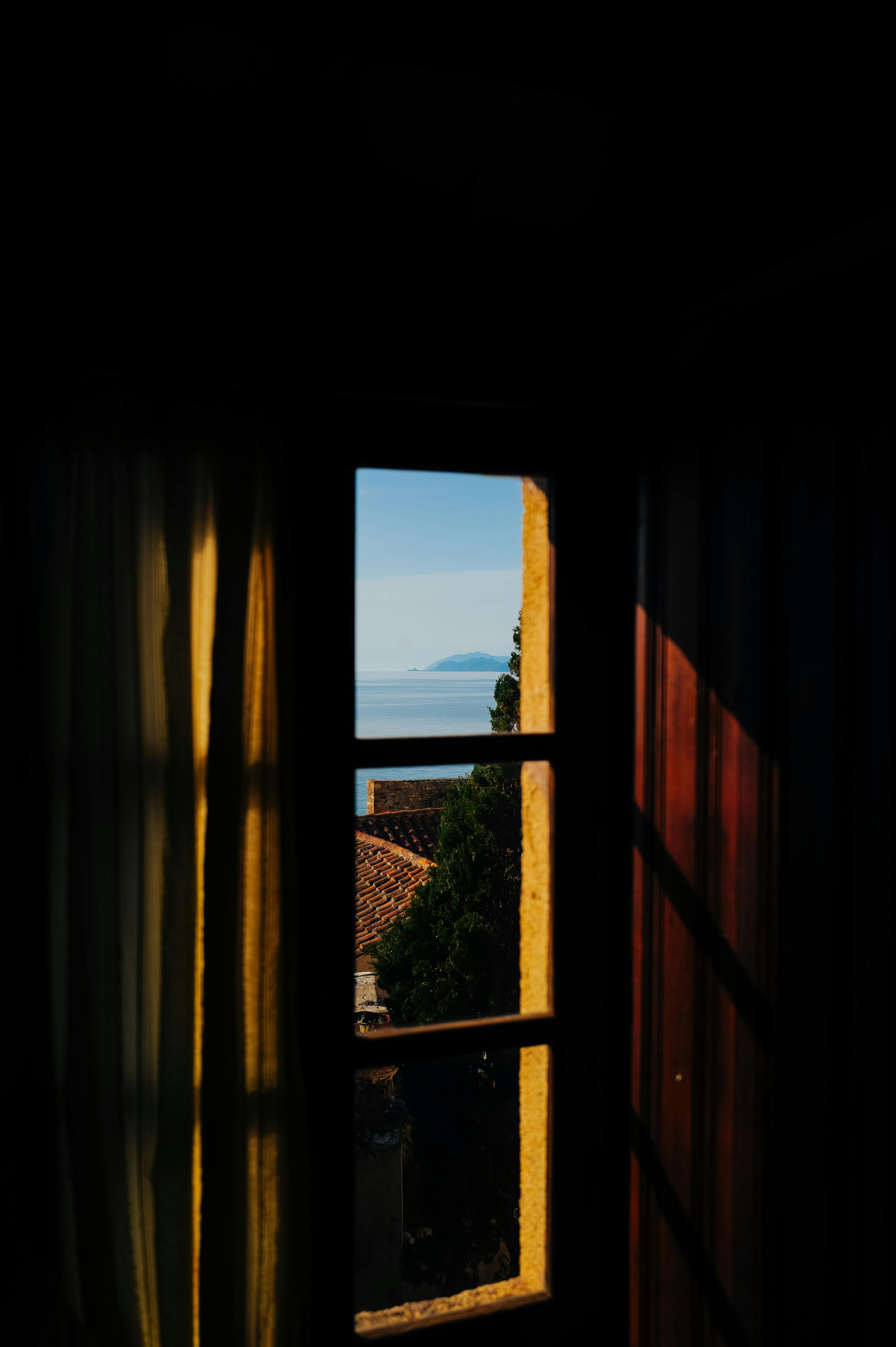 Serene Coastal View Through Window Frame · Free Stock Photo