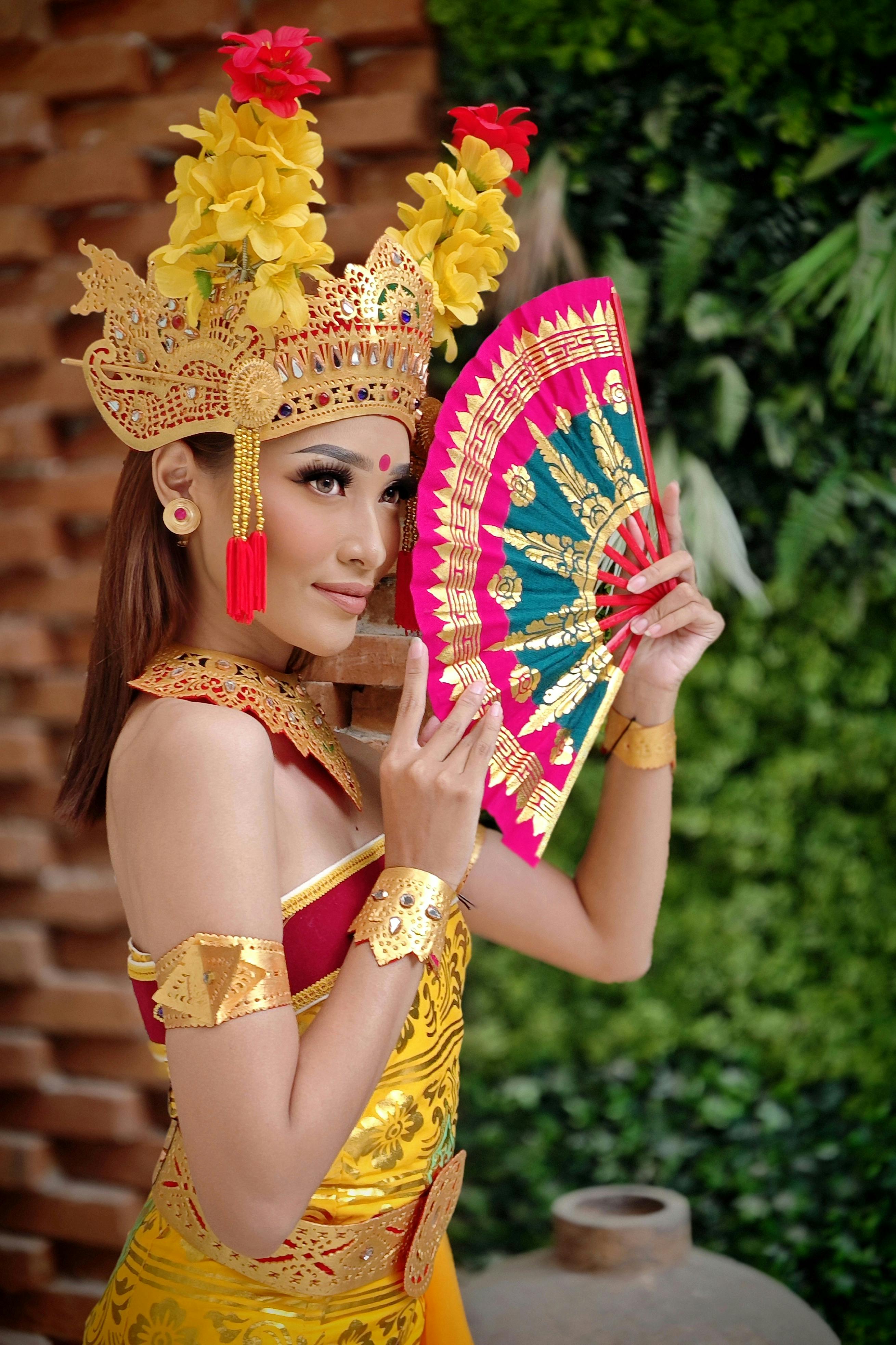 Balinese Dancer in Traditional Costume with Fan · Free Stock Photo