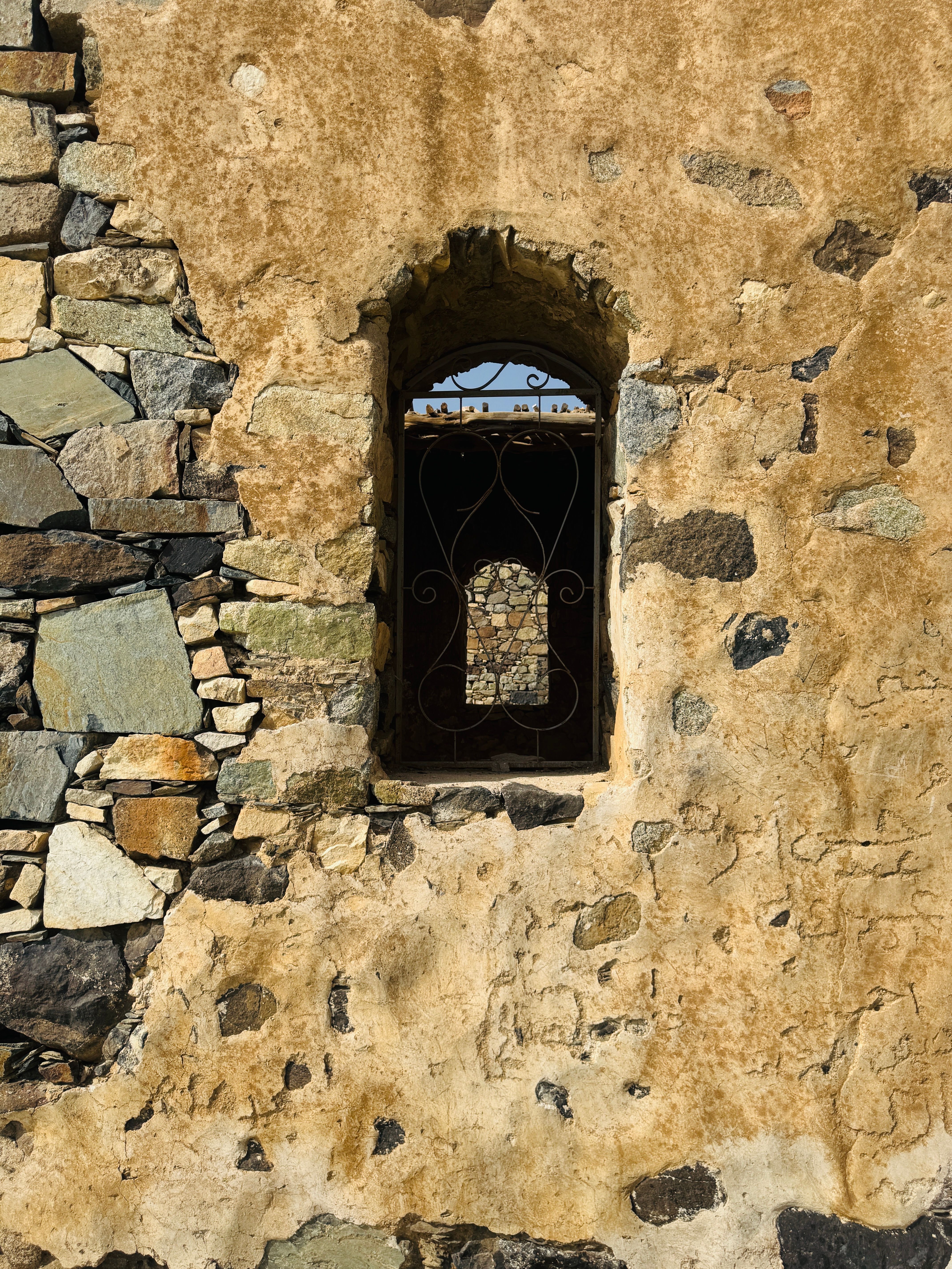 Rustic Stone Wall with Arched Window View · Free Stock Photo
