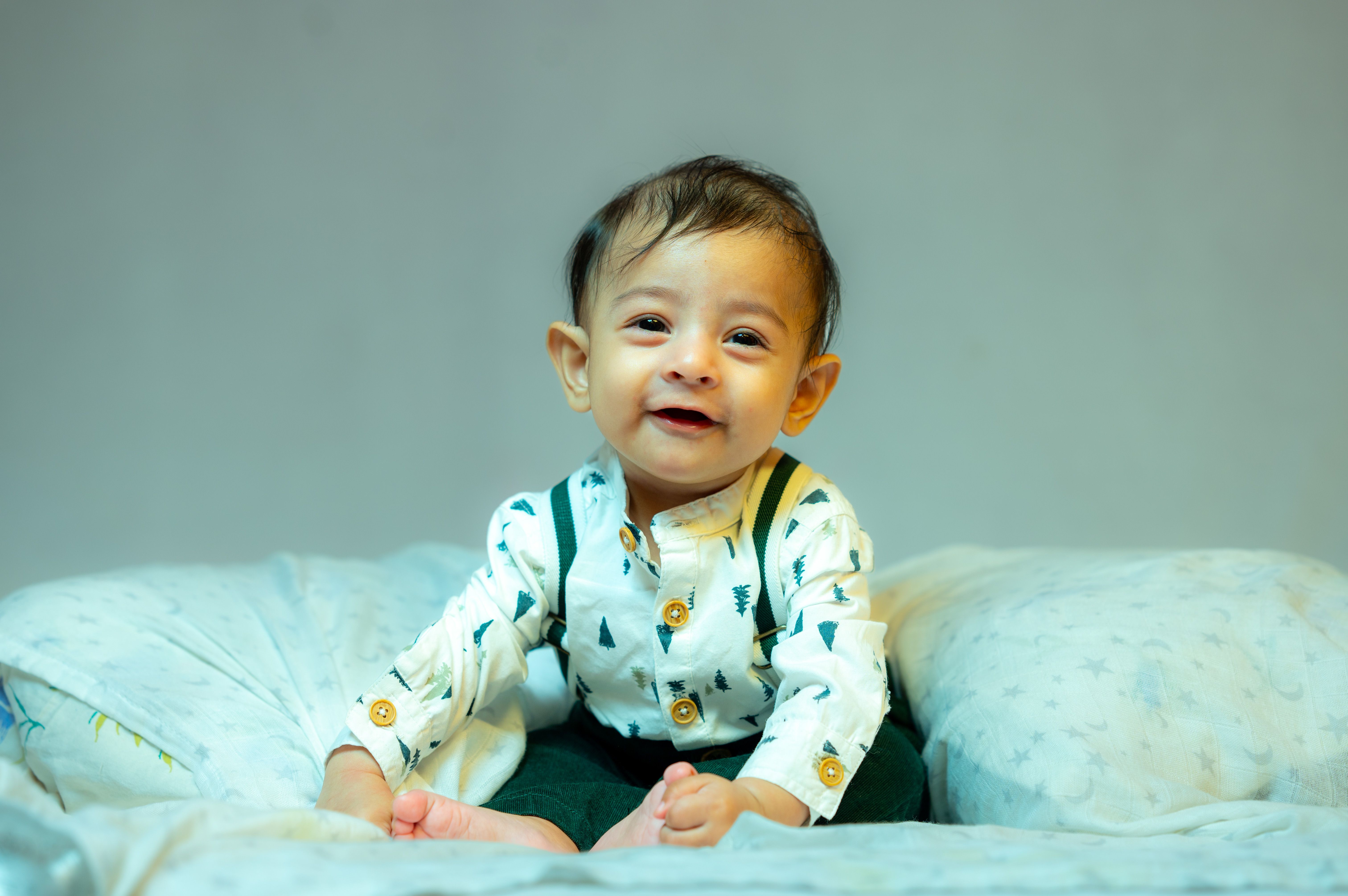 Adorable Baby Smiling in Stylish Outfit Indoors · Free Stock Photo