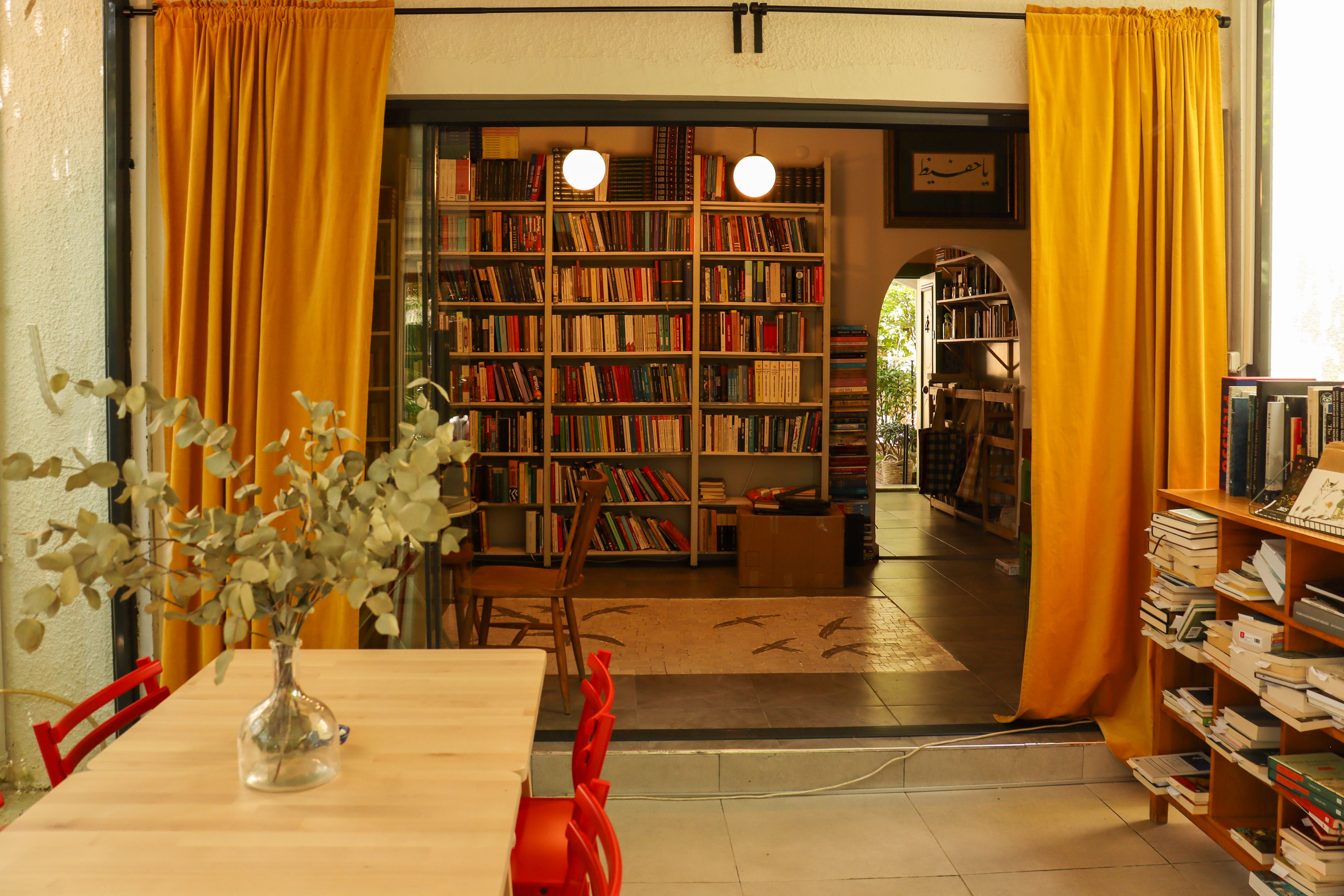 Cozy Library Interior with Books and Bright Curtains · Free Stock Photo