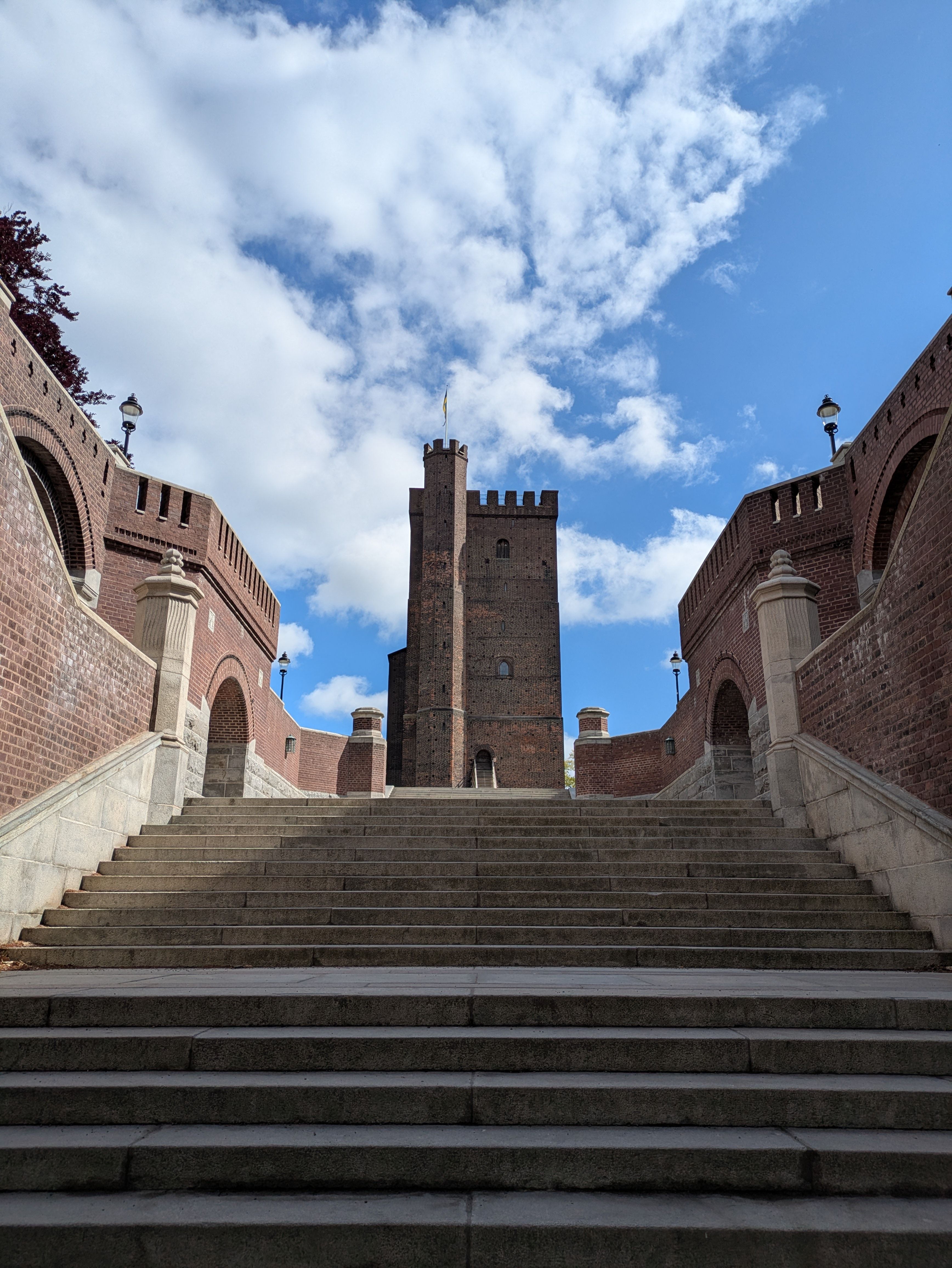 Majestic Brick Tower with Staircase and Arched Entrances · Free Stock Photo