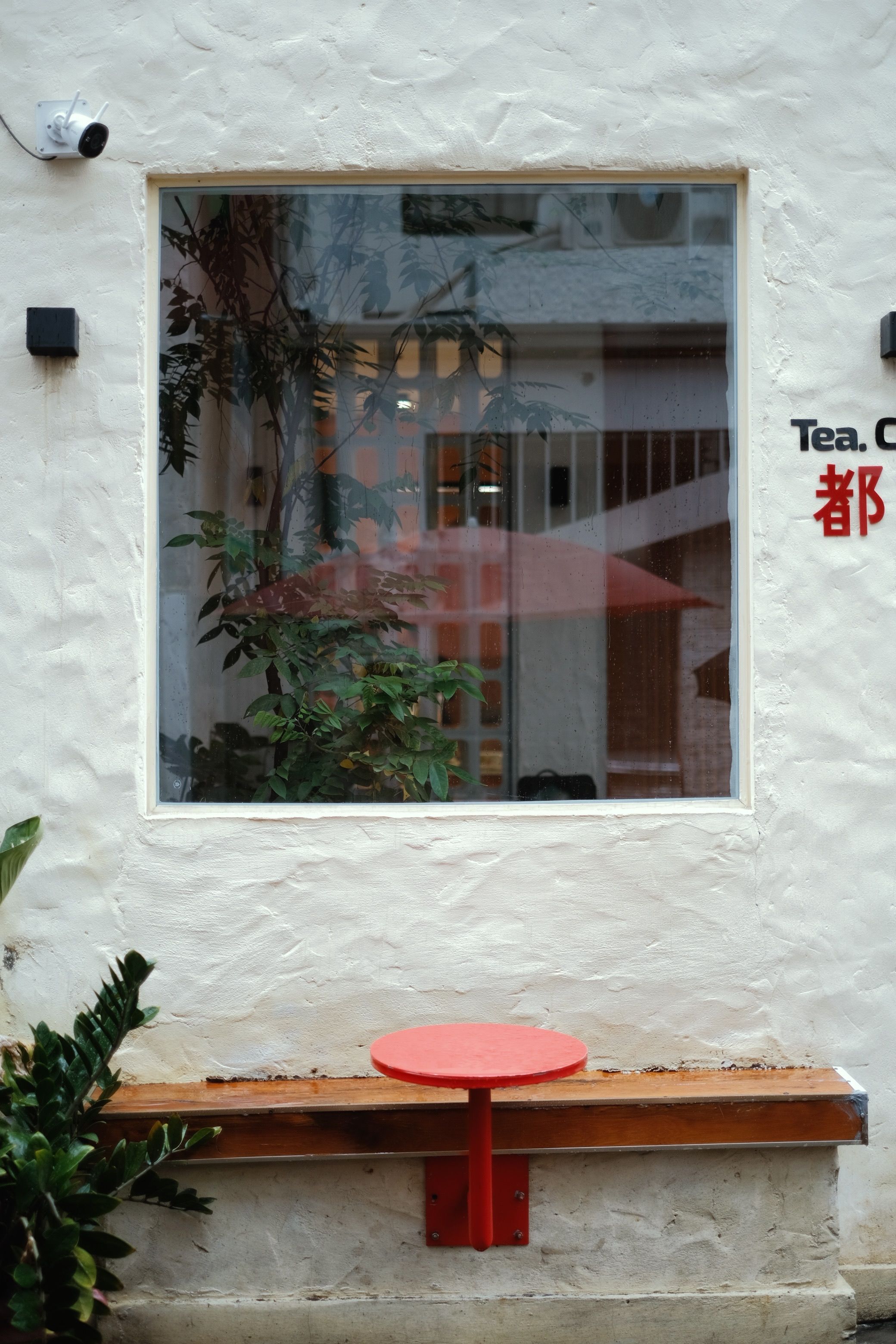 Charming Café Window with Red Table · Free Stock Photo