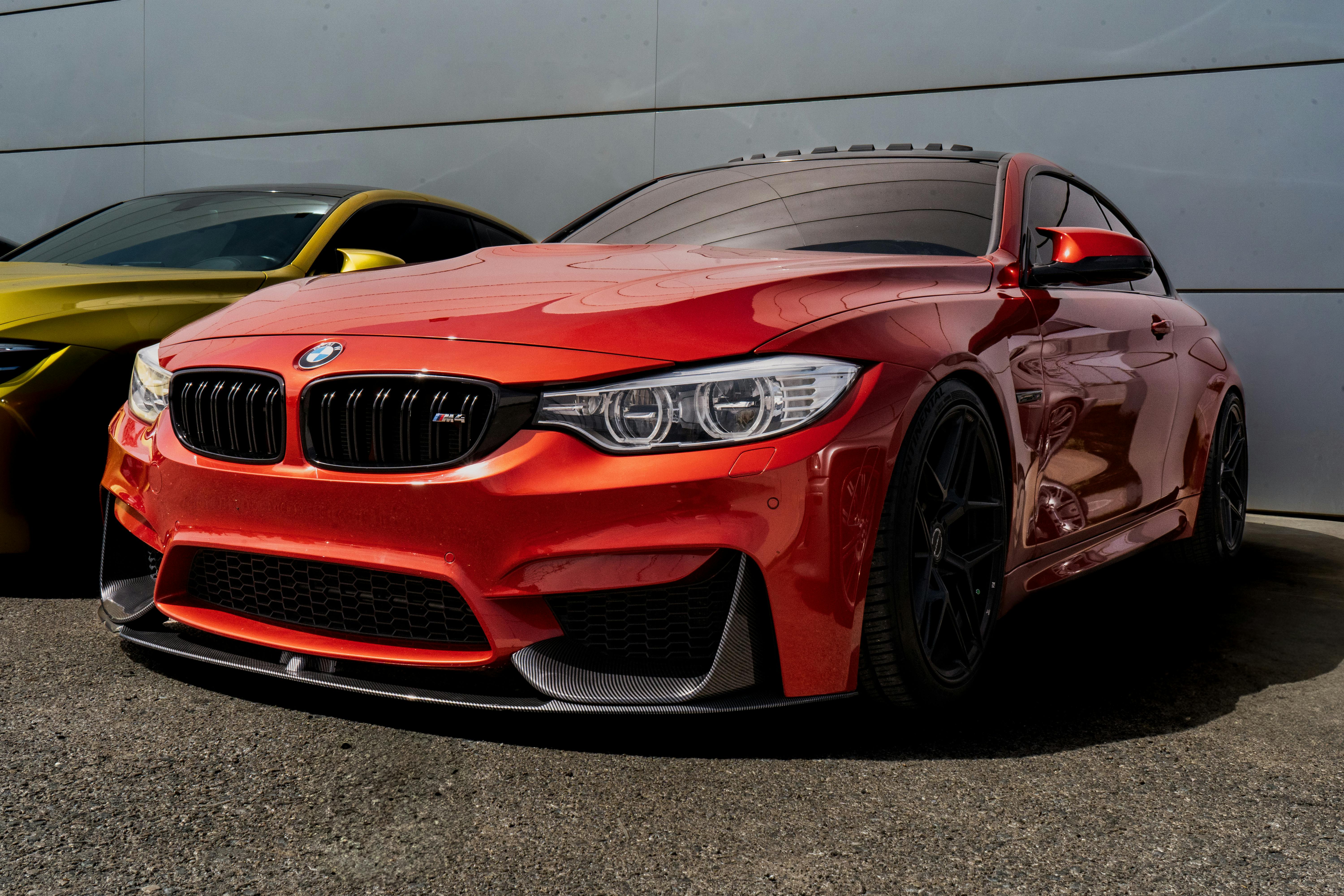 Bright Red Sports Car in Urban Setting · Free Stock Photo